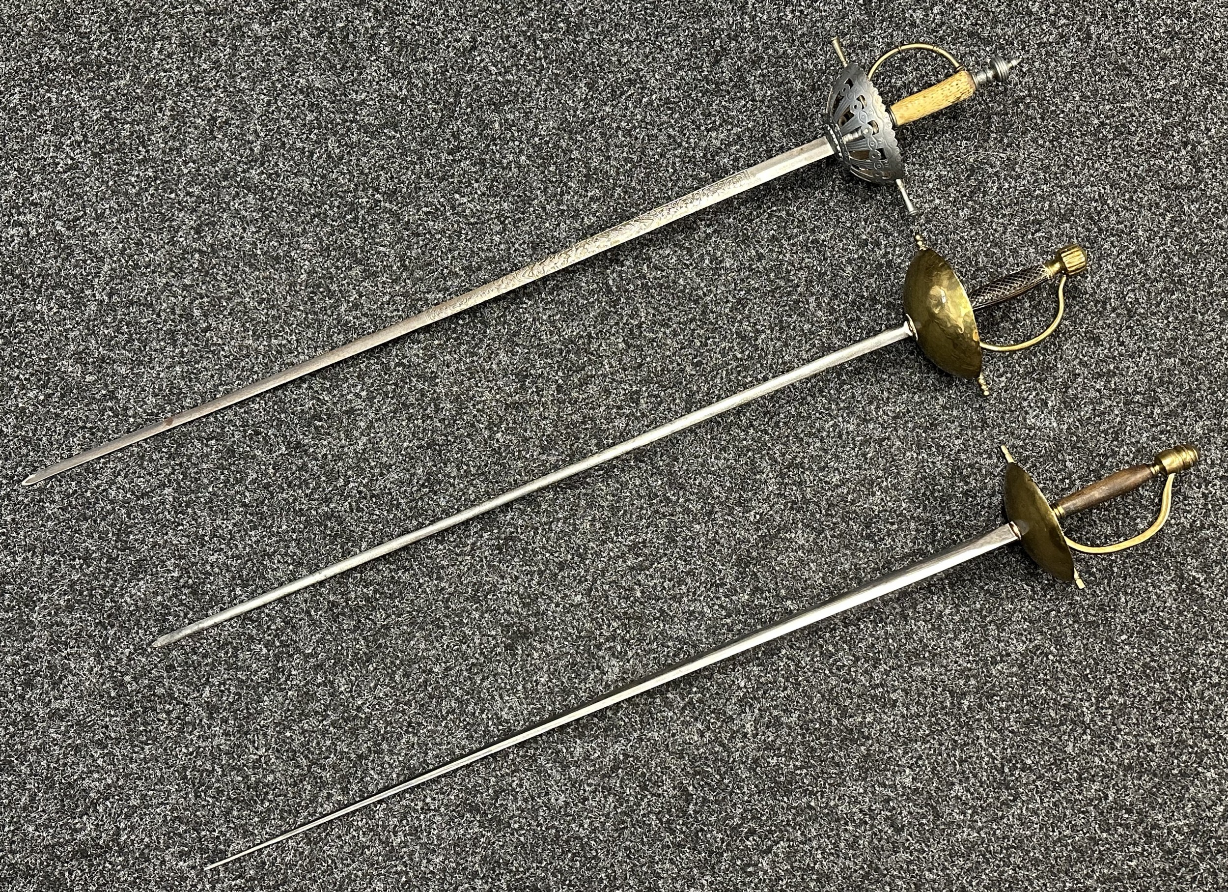 A collection of three Rapiers: One with decorated etched double edged ...