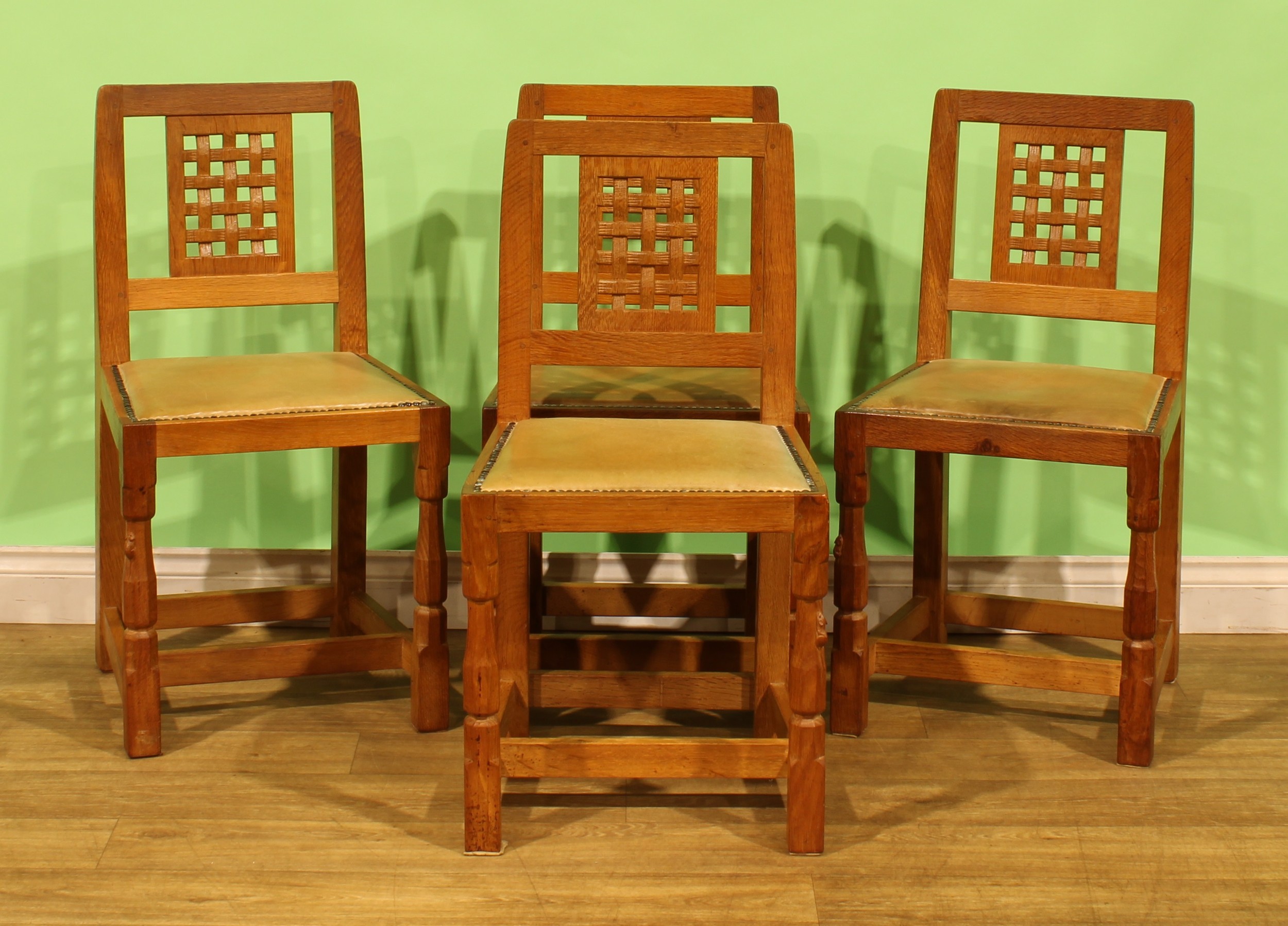 Robert Thompson, Mouseman of Kilburn - a set of four oak dining chairs ...