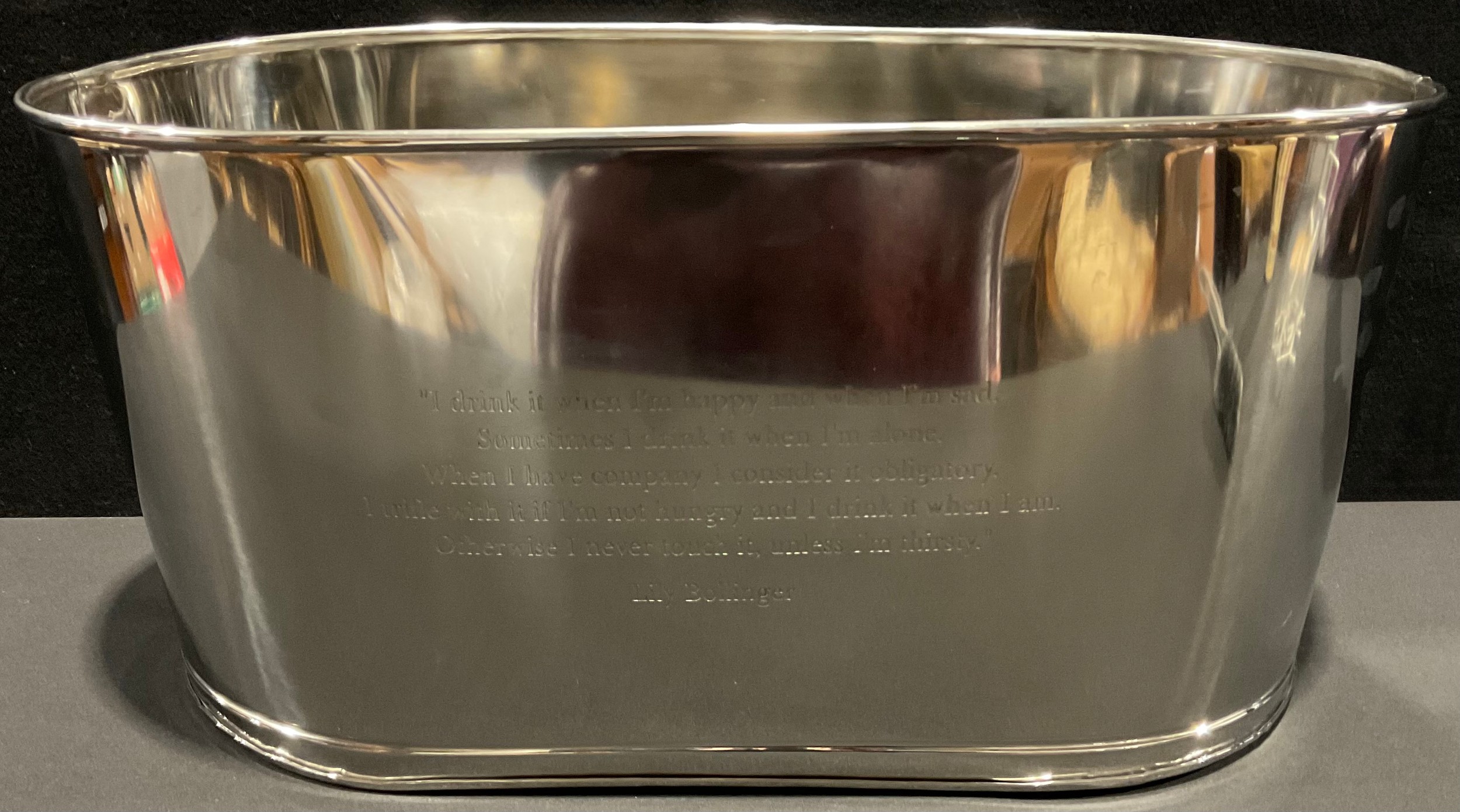 A modern chrome champagne trough inscribed with Lili Bollinger quote ...