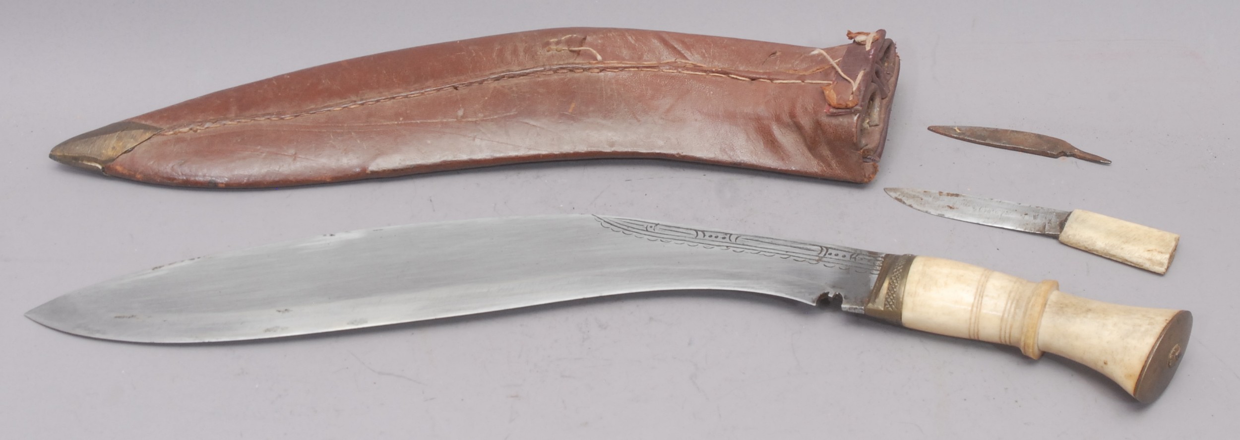 Tribal Art - a Nepalese kukri knife, the blade engraved with floral ...
