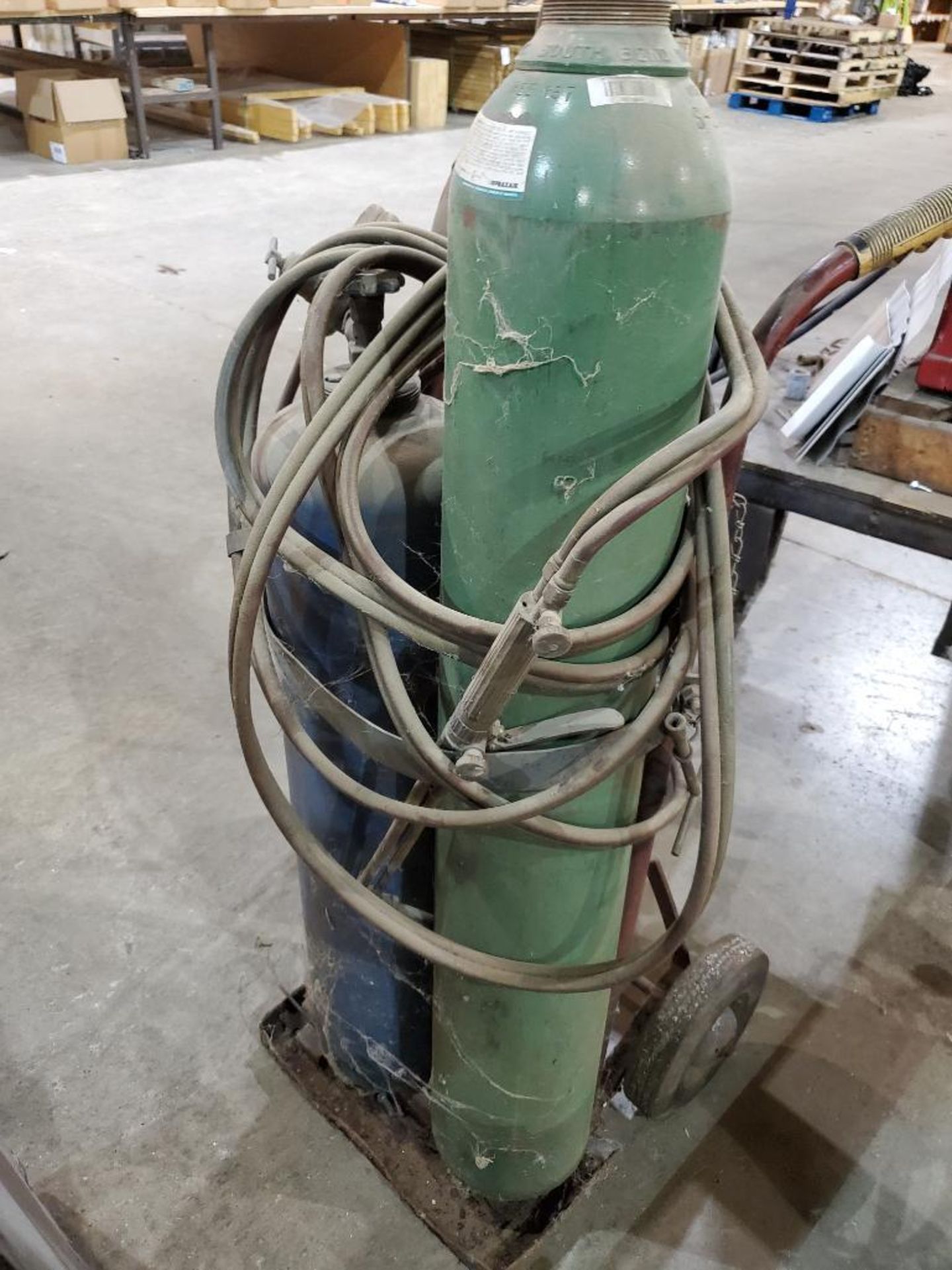 Torch cart with torch hoses and head. Includes tanks.