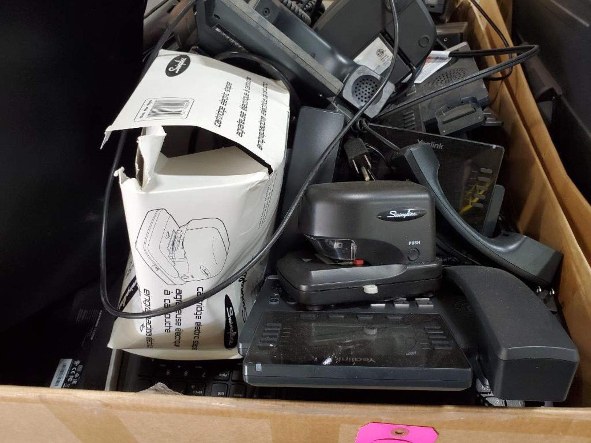Box of assorted computers peripherals.