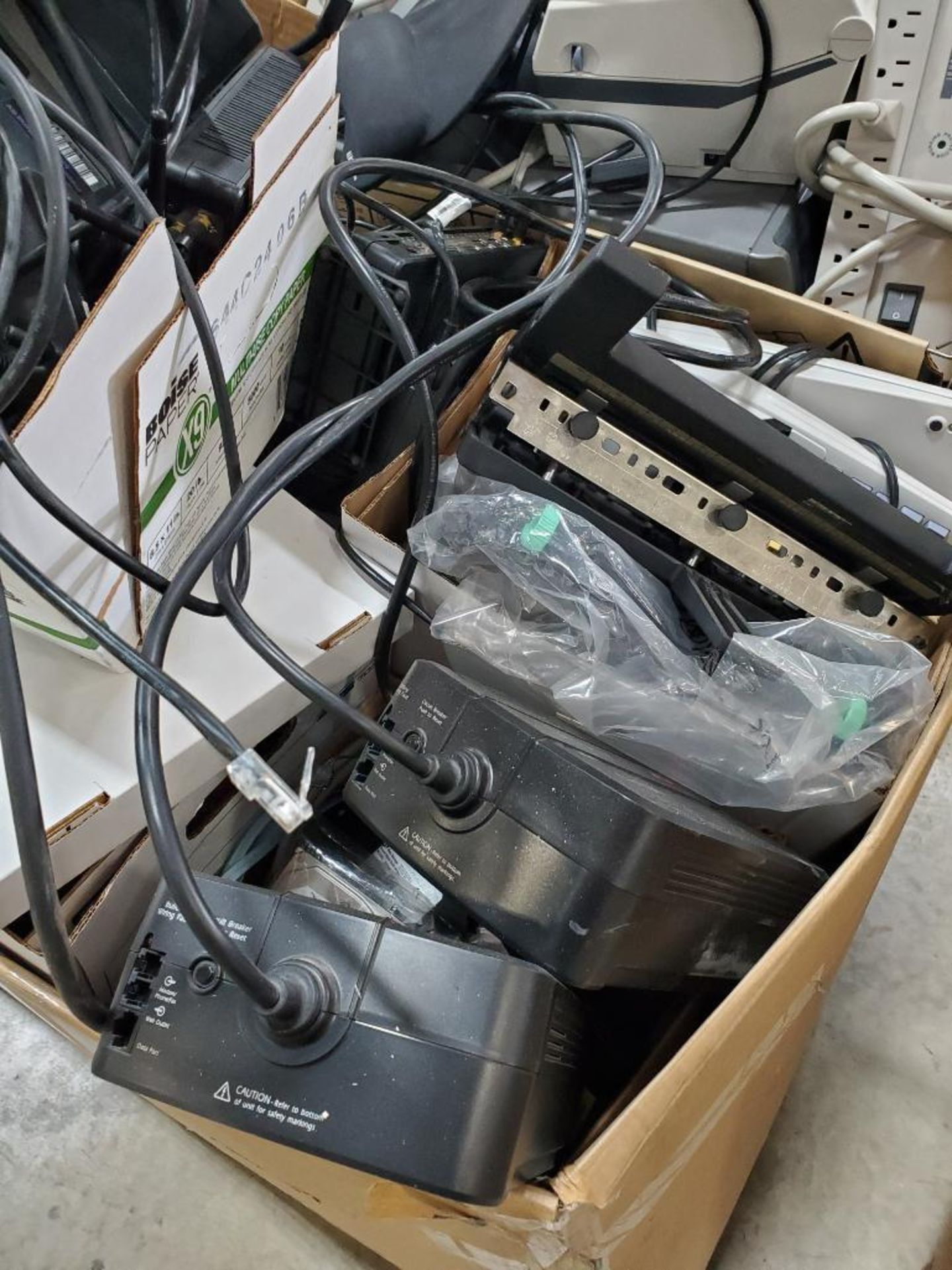 Box of assorted computers peripherals.