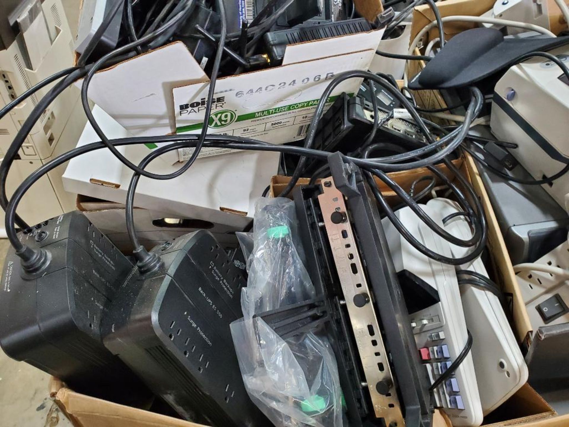 Box of assorted computers peripherals.