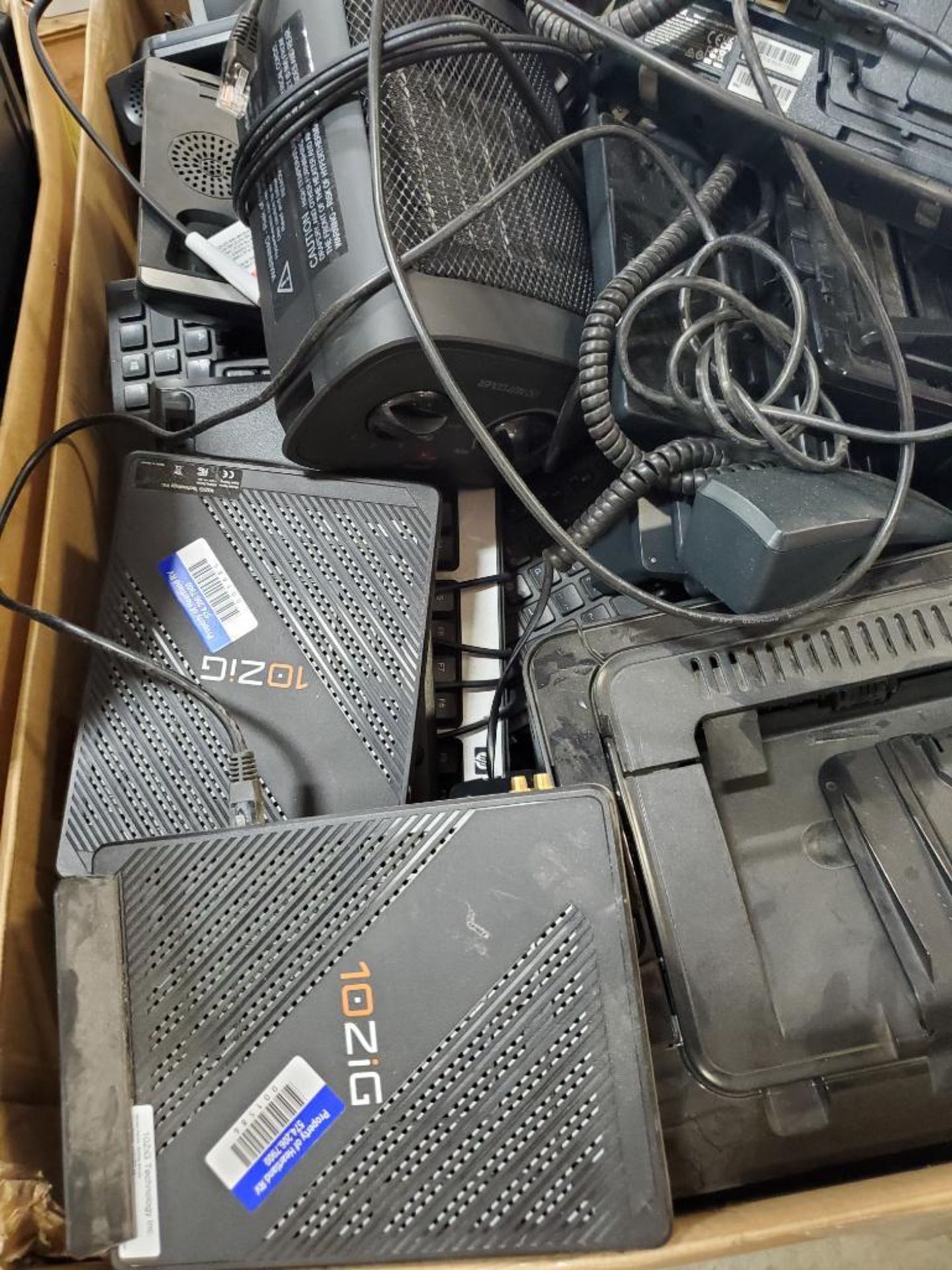 Box of assorted computers peripherals.