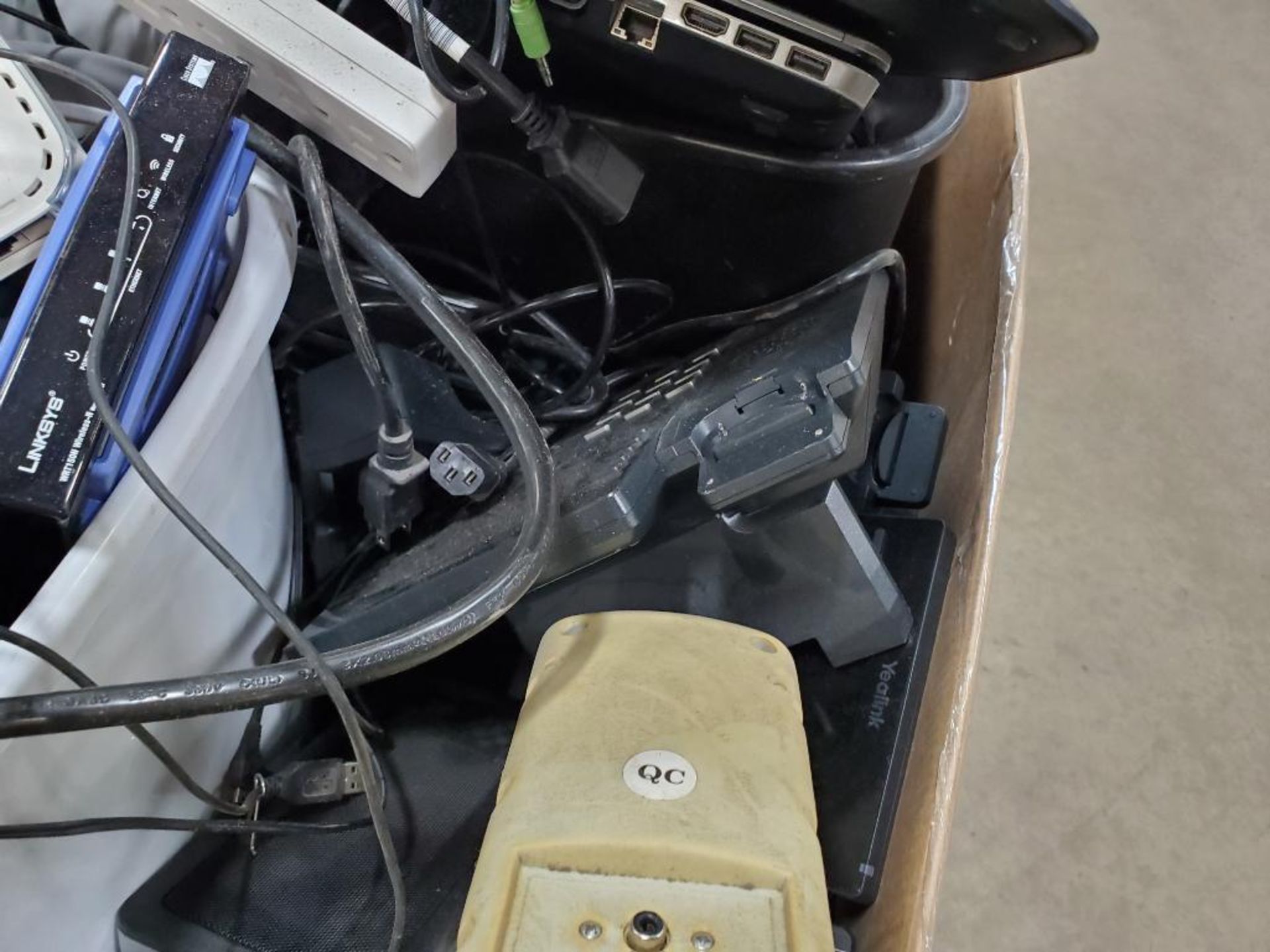 Box of assorted computers peripherals.