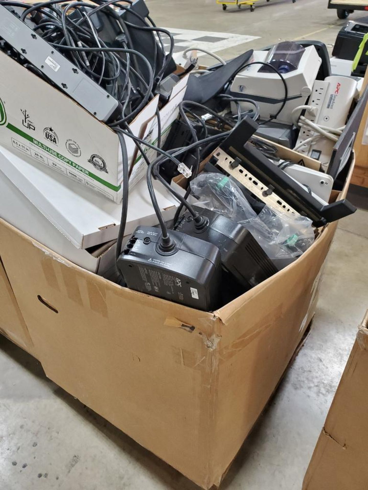Box of assorted computers peripherals.