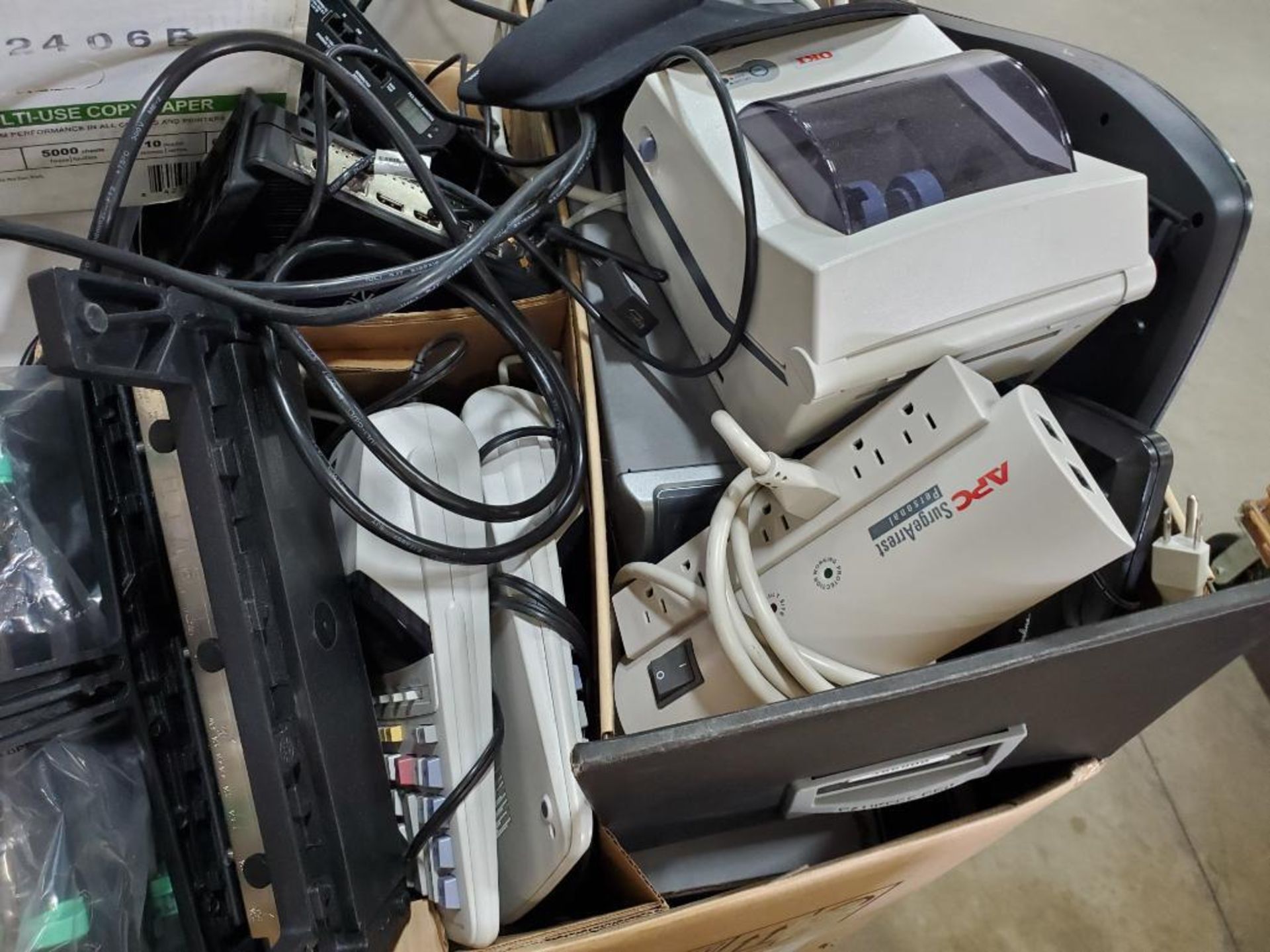 Box of assorted computers peripherals.
