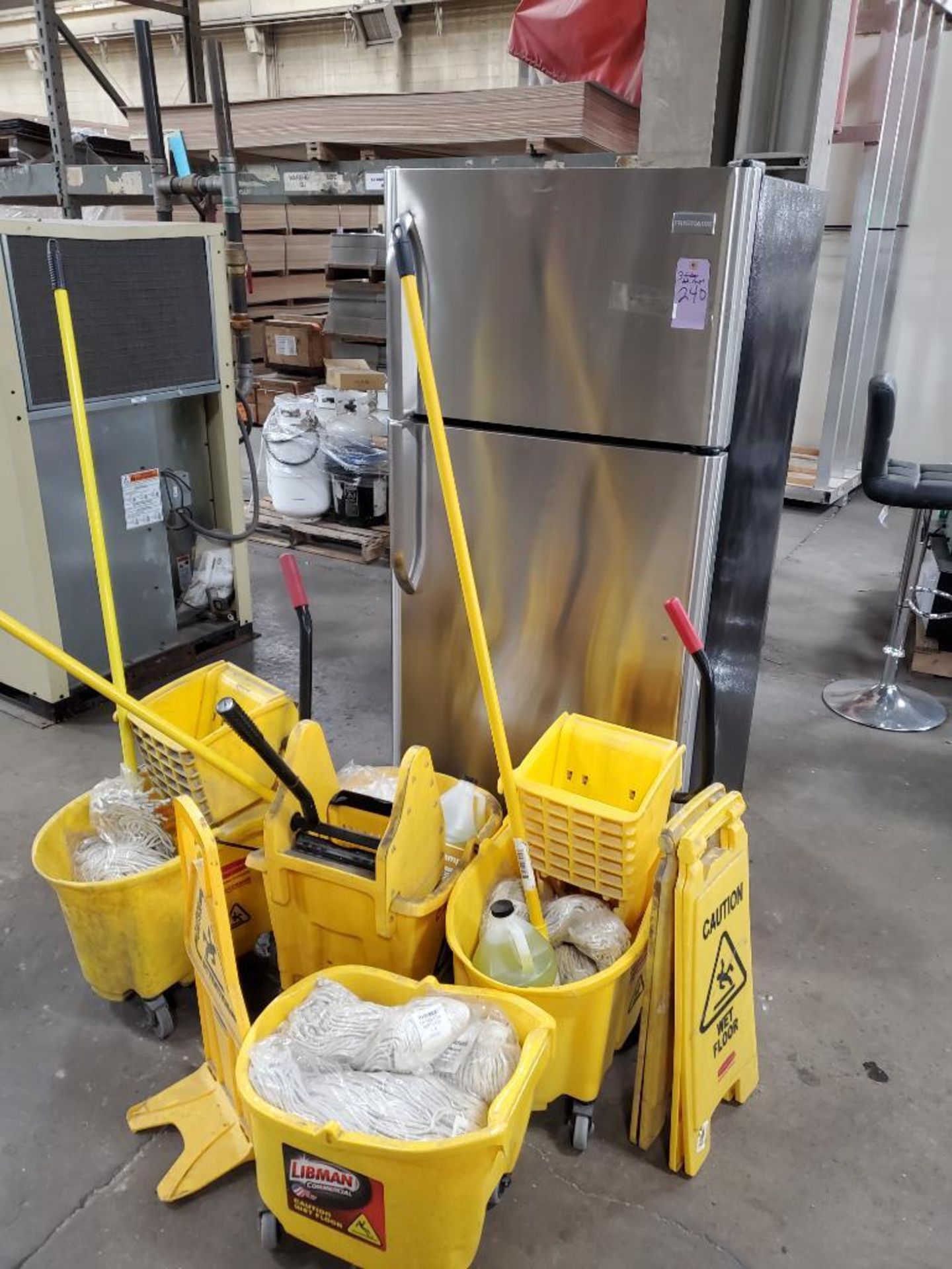 Assorted mop buckets and refrigerator.