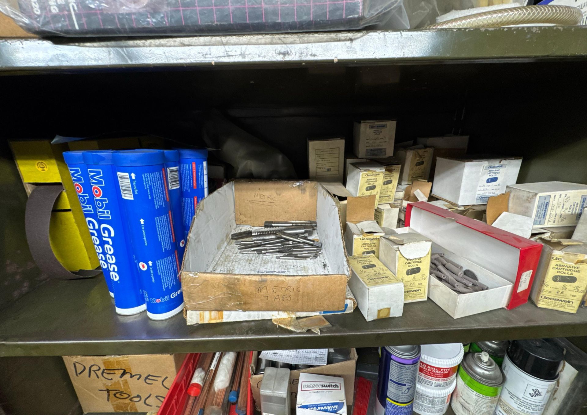 Storage cabinet with contents. Contents include metal taps, mold, hoses ...