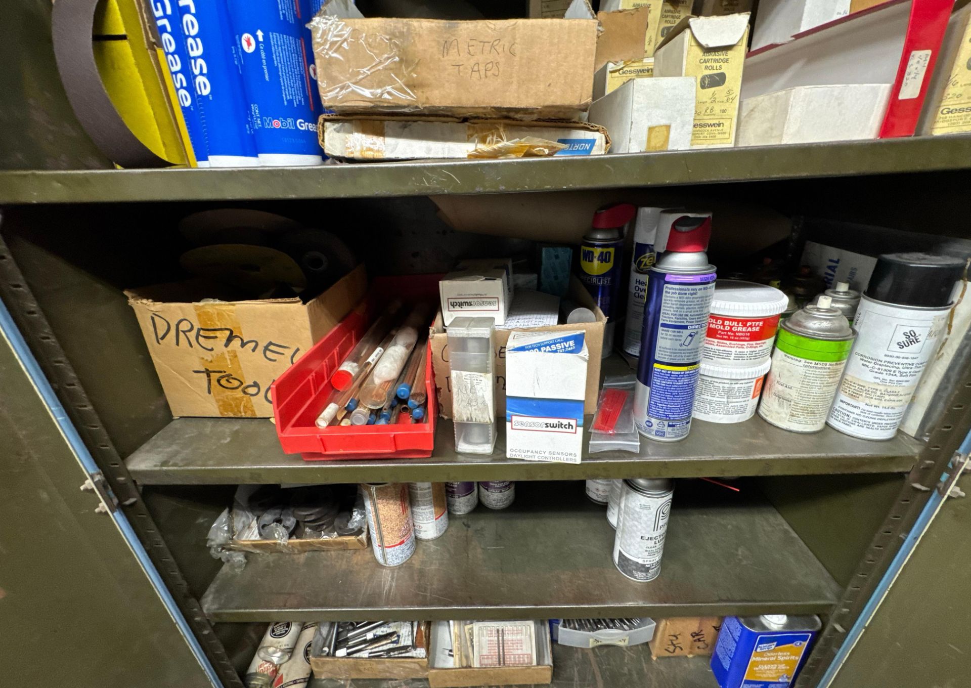 Storage cabinet with contents. Contents include metal taps, mold, hoses ...