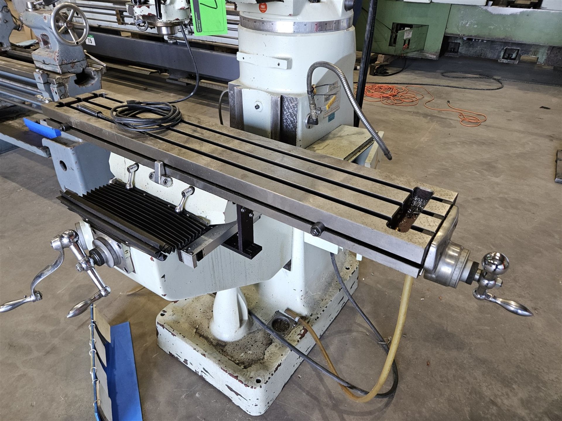 FIRST MILLING MACHINE, MODEL LC- 1 1/2 VS, 220V, 9 IN. X 50 IN. TABLE W ...