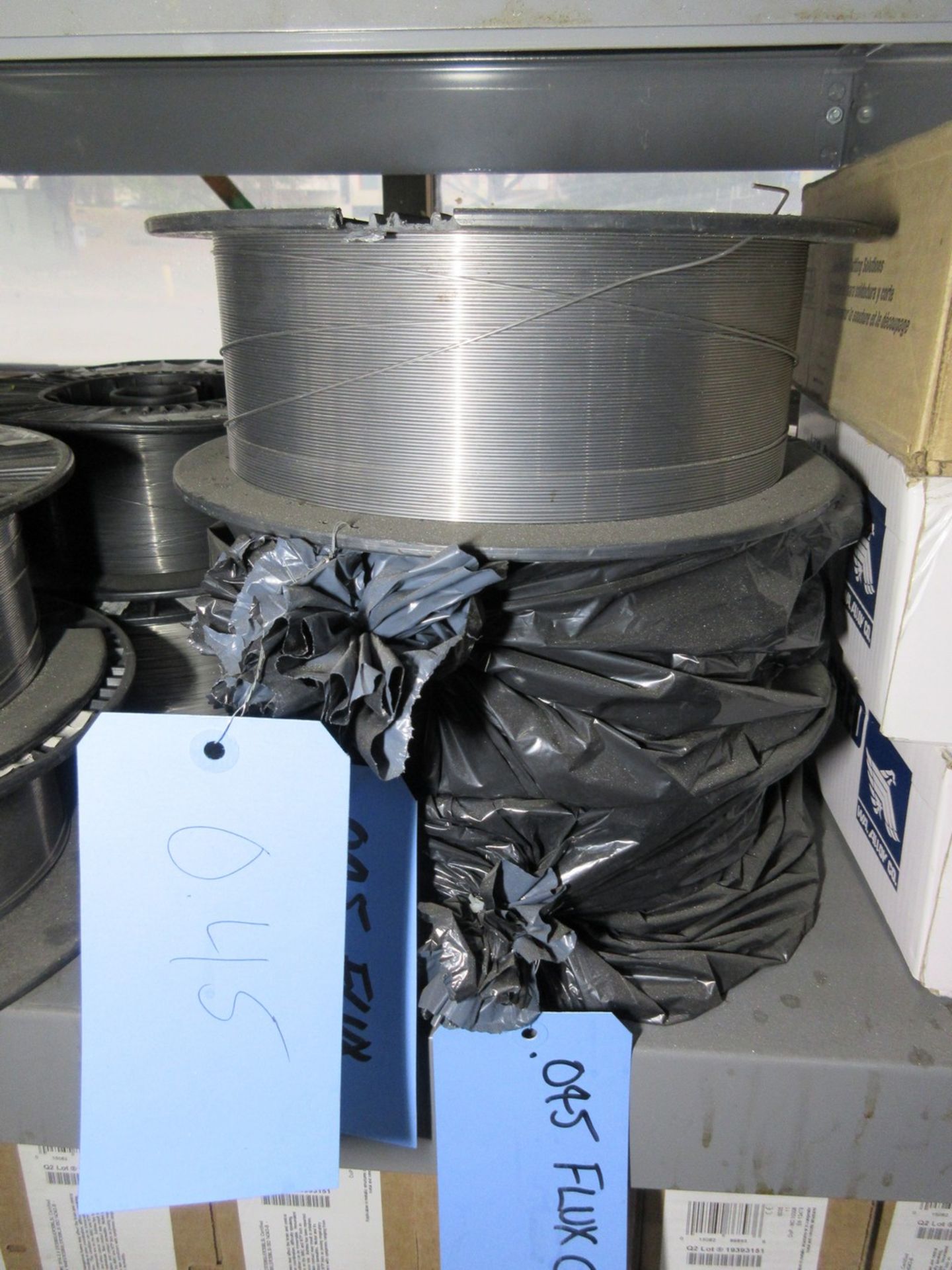 Assorted Spools of MIG Welding Wire on Shelf