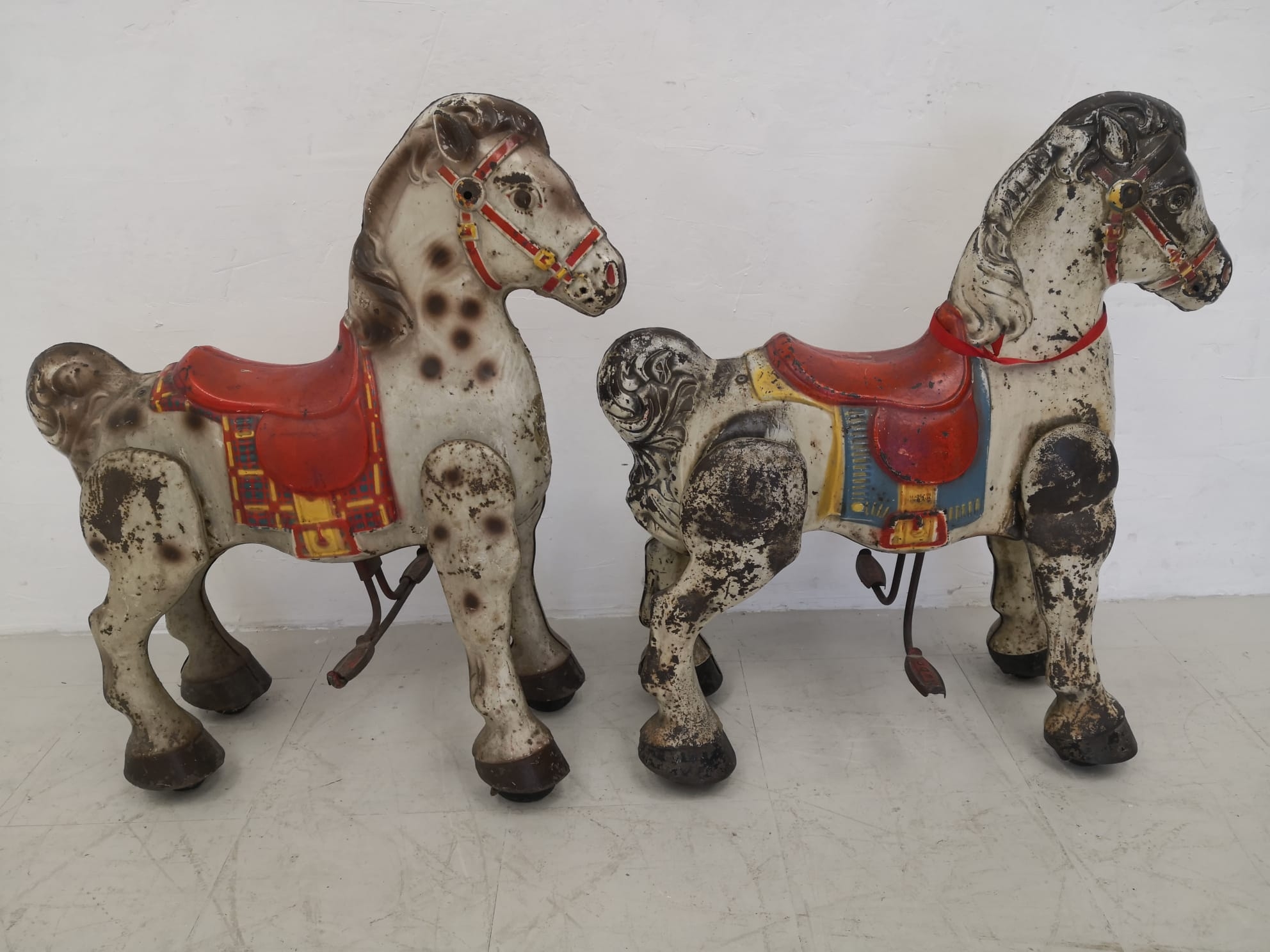 Two 1950s hand painted tin Mobo bronco horses with dapple grey finishes ...