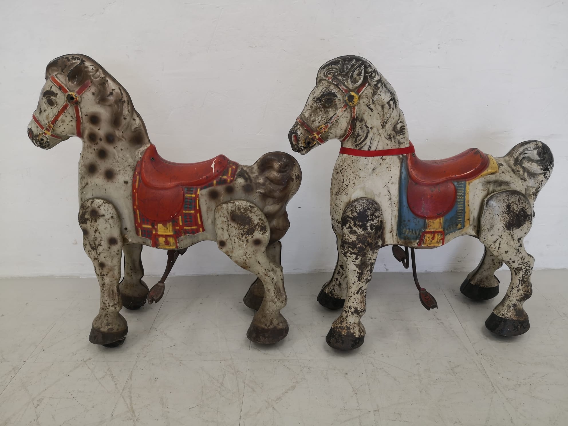Two 1950s hand painted tin Mobo bronco horses with dapple grey finishes ...
