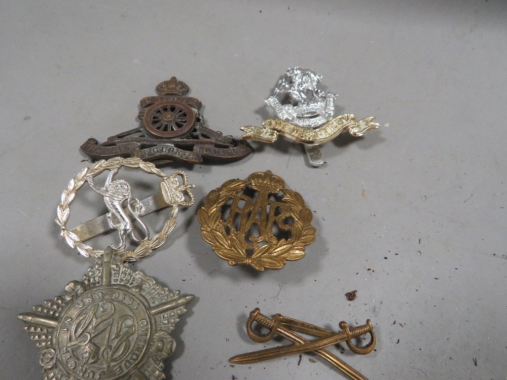A bag of assorted military badges and buttons