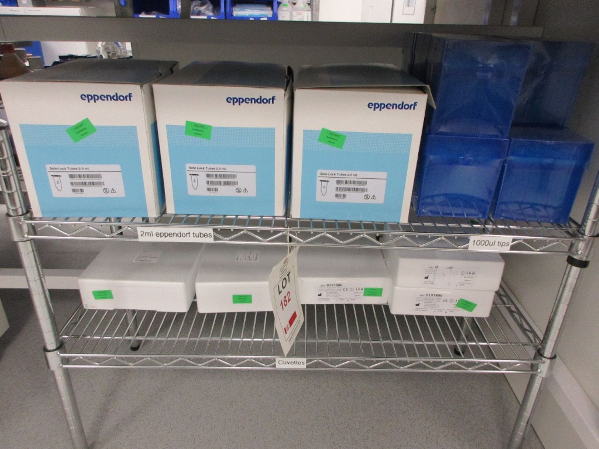 Chrome frame 2-shelf storage rack with contents including cuvettes ...