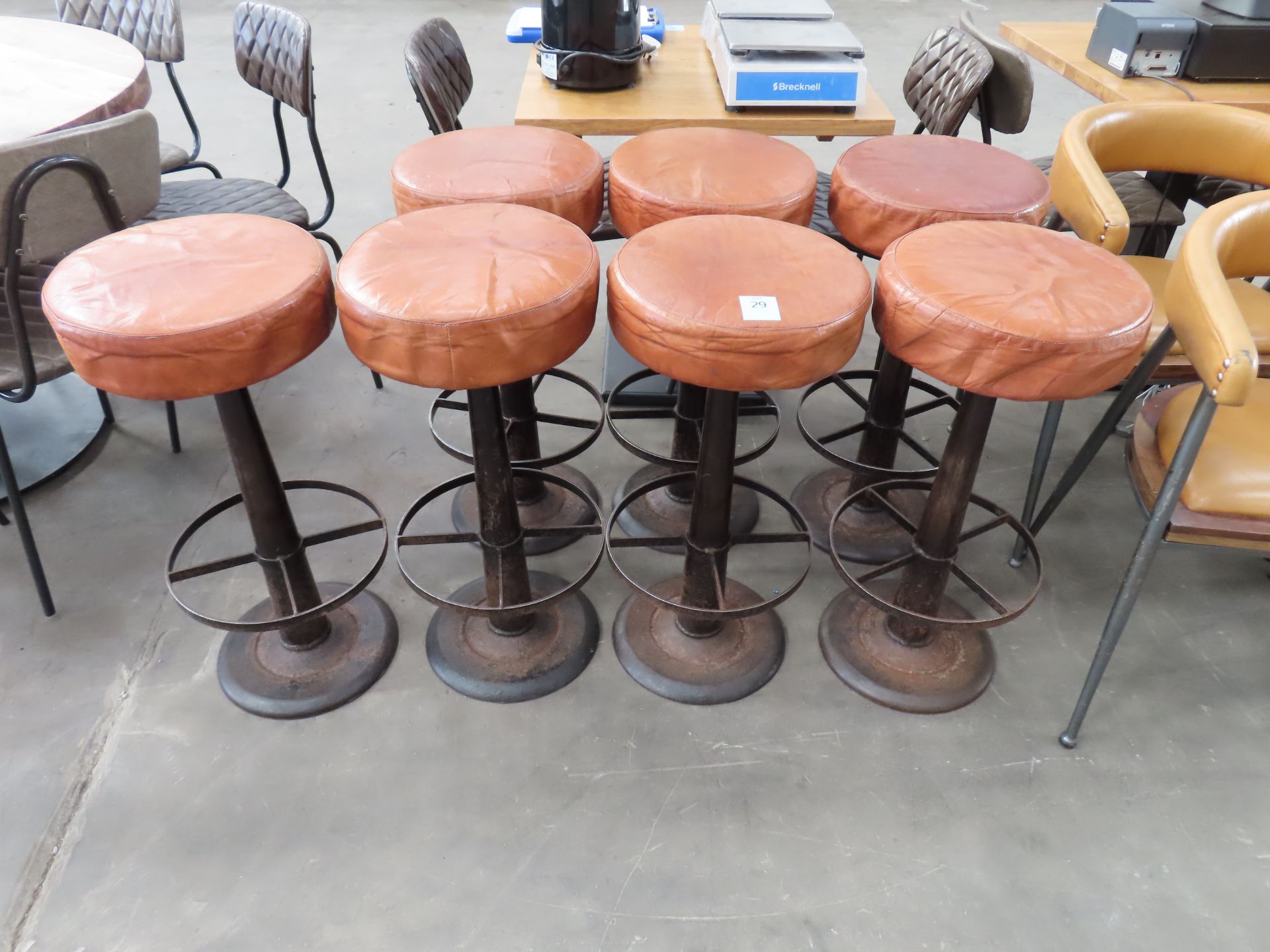 7x Metal Bar Stools with Leather Effect Tops.