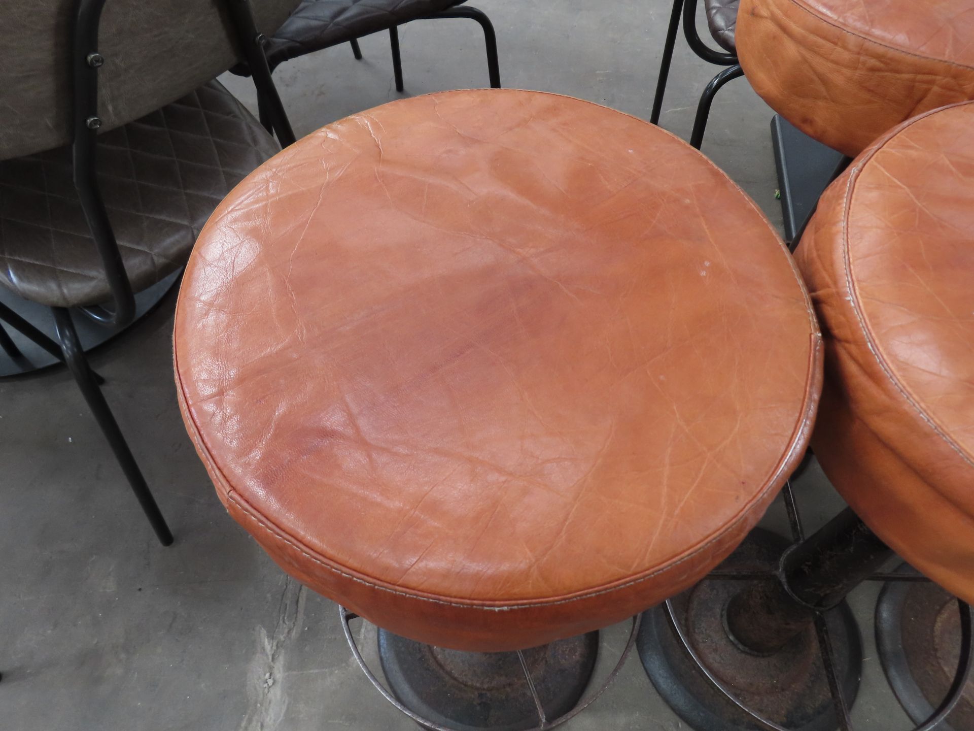 7x Metal Bar Stools with Leather Effect Tops.