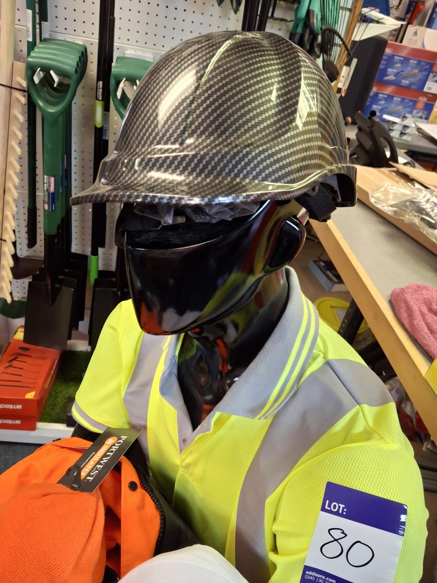 Seated mannequin with quantity of PPE clothing