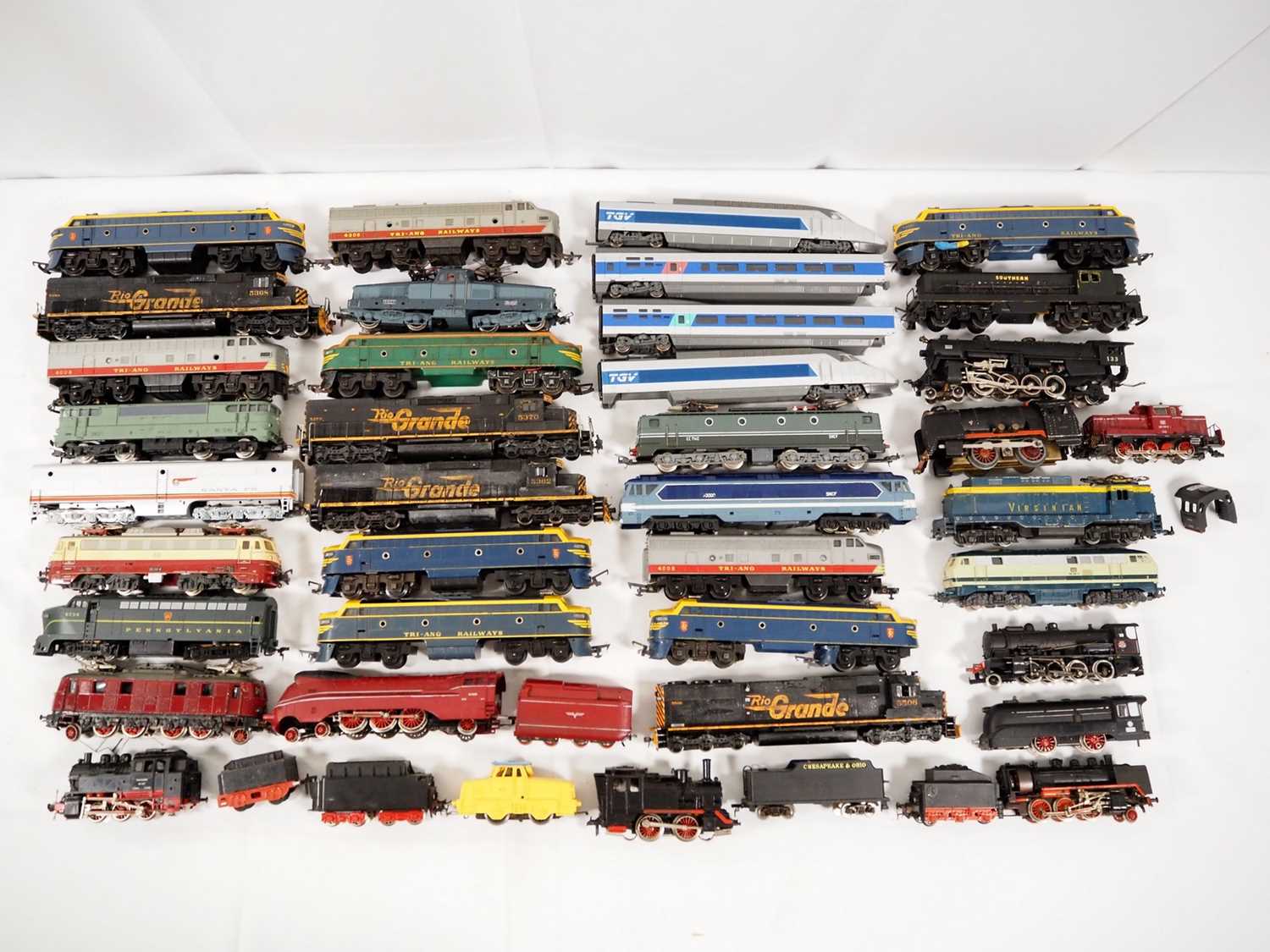 A large crate of HO gauge unboxed locomotives and rolling stock by ...