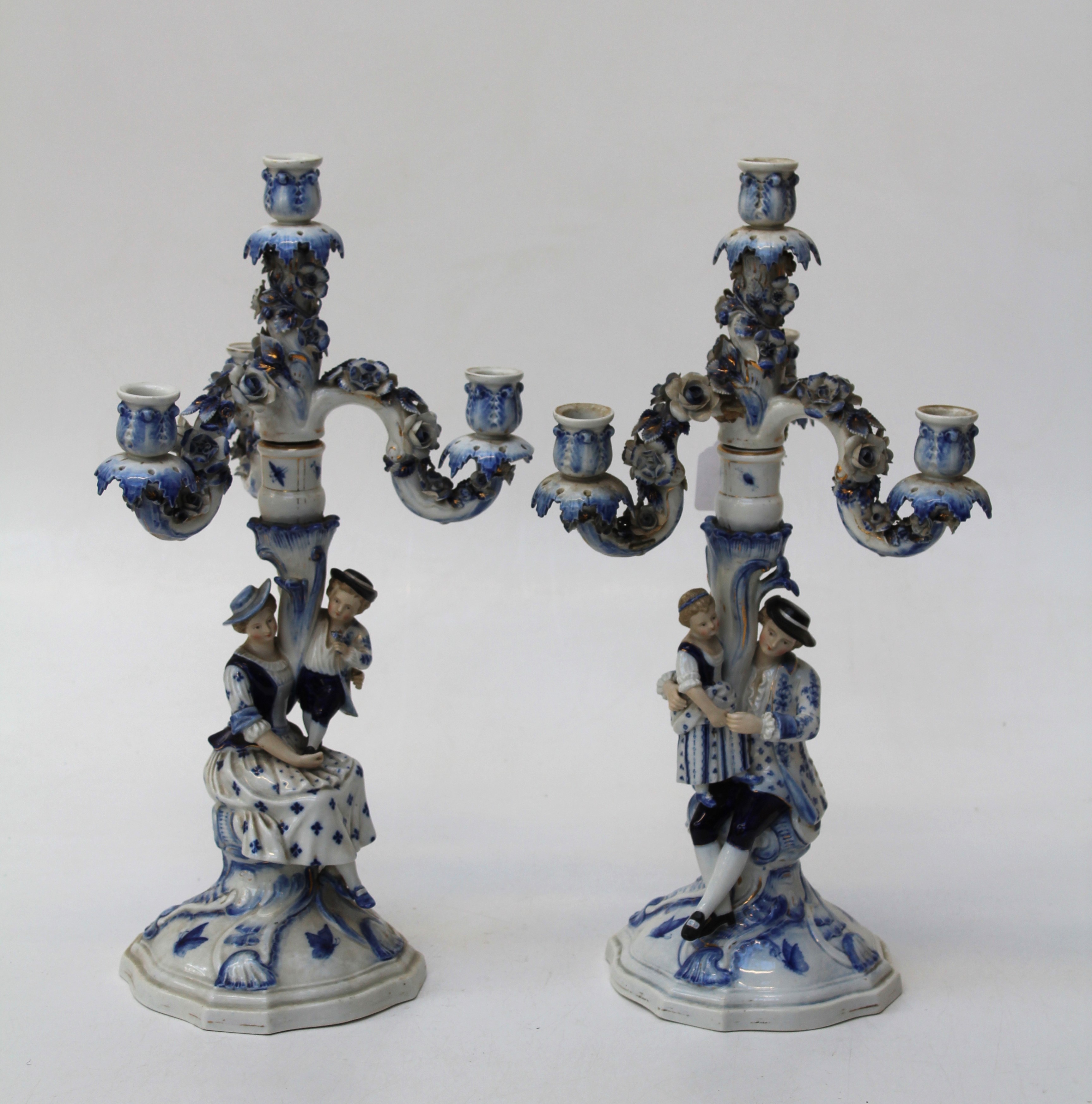 A pair of late 19th century Dresden figural three branch table ...