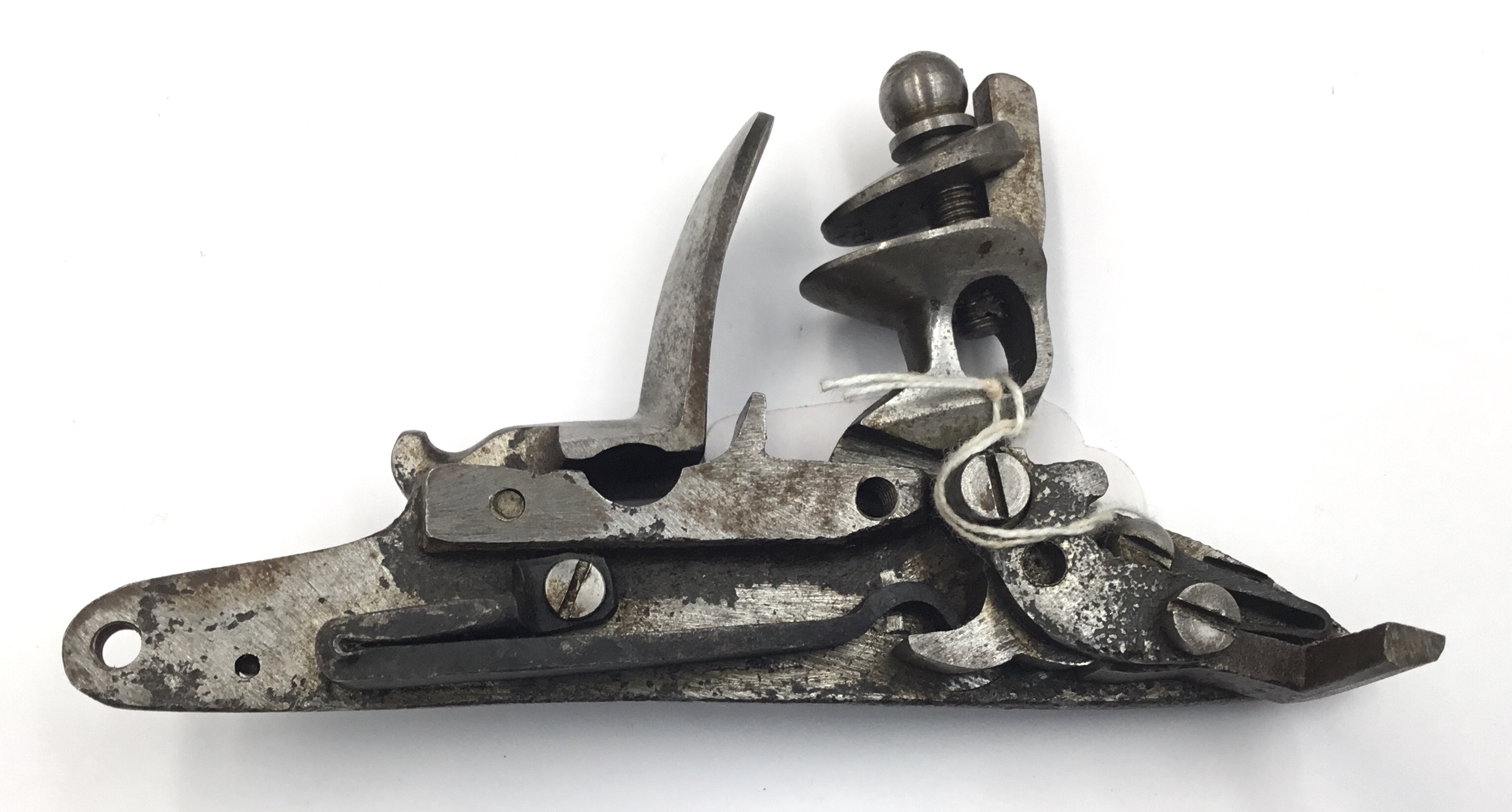 An antique detached lock from a flintlock gun, possibly an English ...