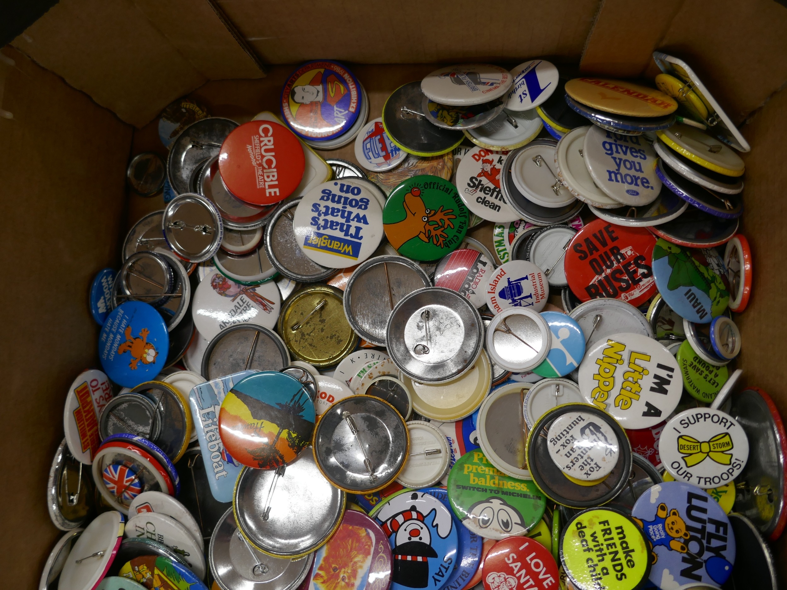A large collection of pin badges