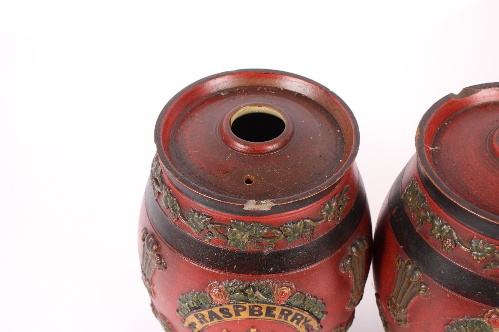 A pair of 19th Century red glazed pottery barrels, with vine and floral ...