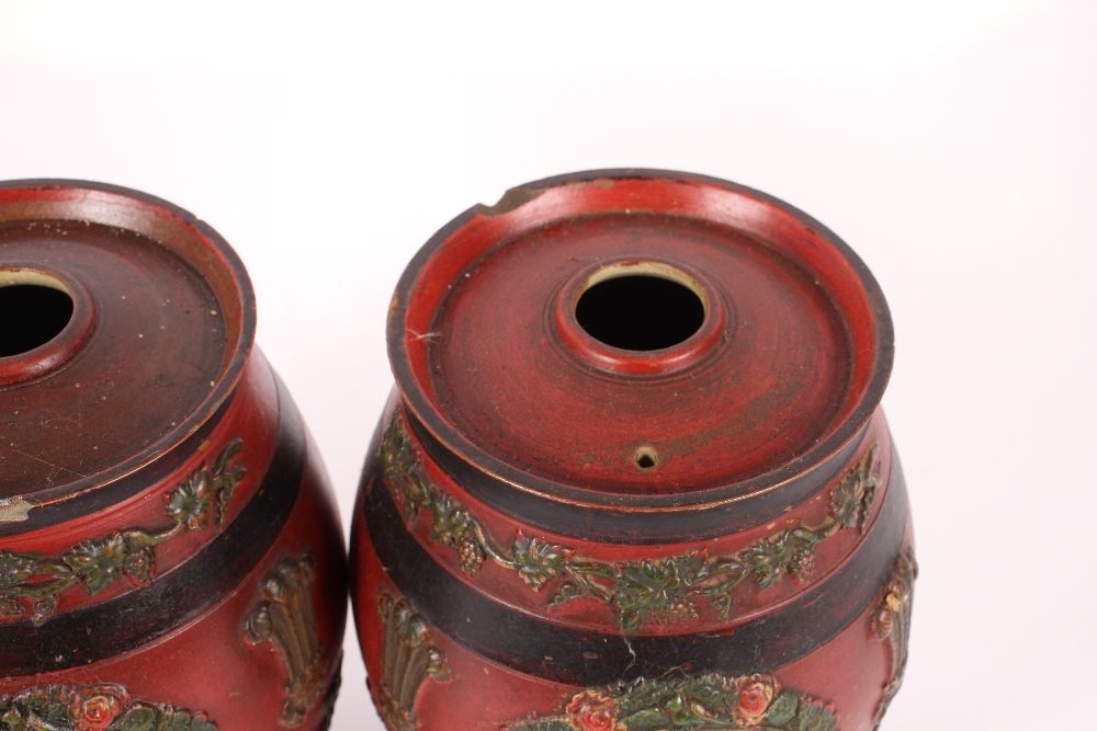 A pair of 19th Century red glazed pottery barrels, with vine and floral ...