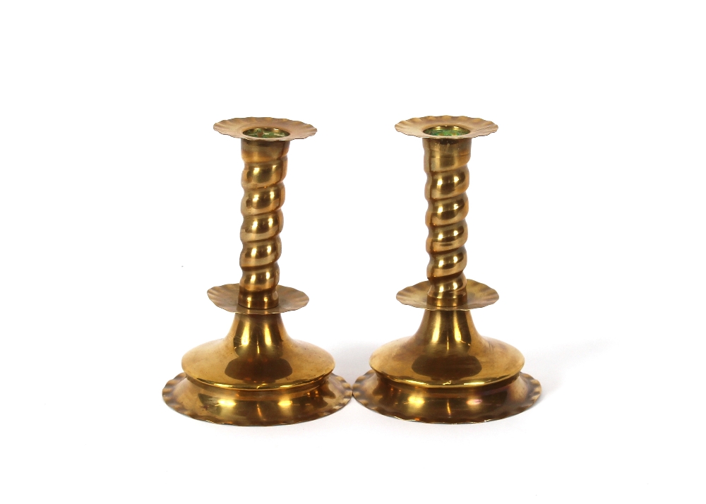 A pair of 17th Century brass candlesticks, with spiral stems, collar ...