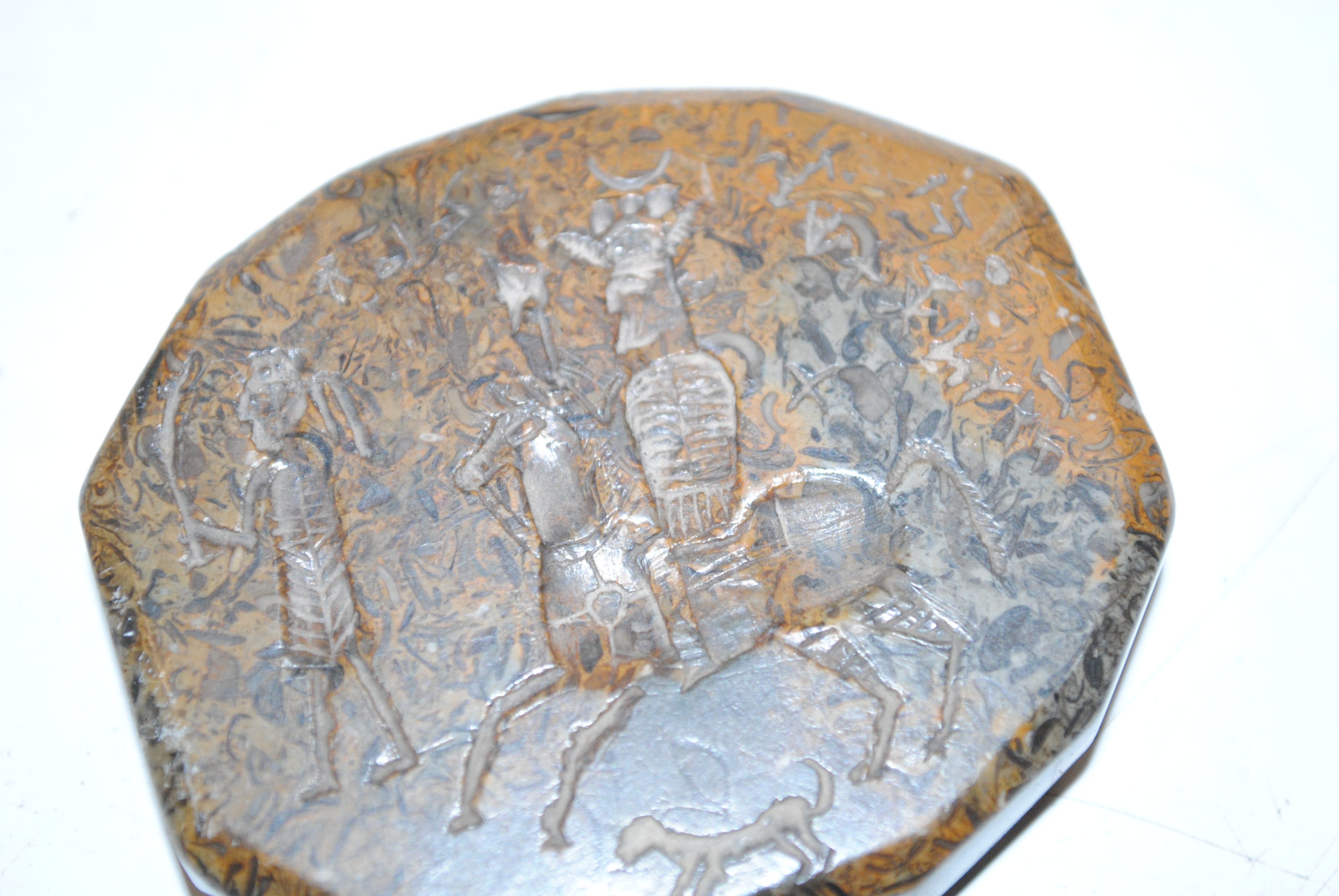 A carved stone tablet decorated with figures and script