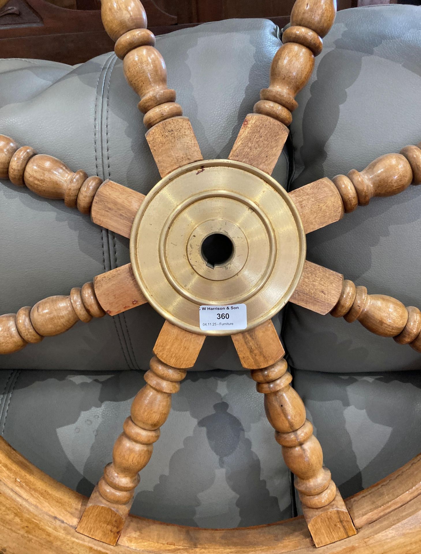 A polished light wood eight prong ship's wheel with brass centre, 93cm ...