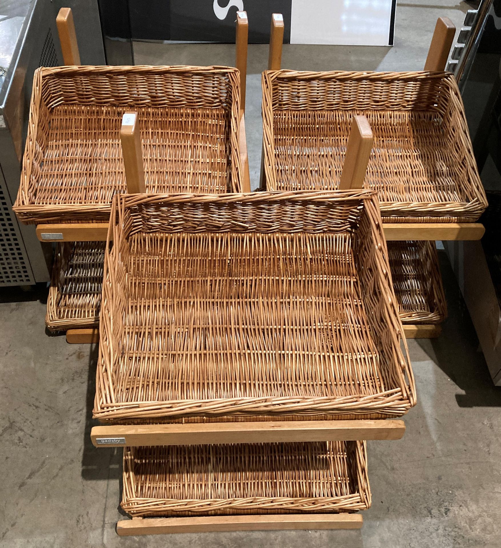 A set of three Gadsby wicker two tier display units with lift off ...
