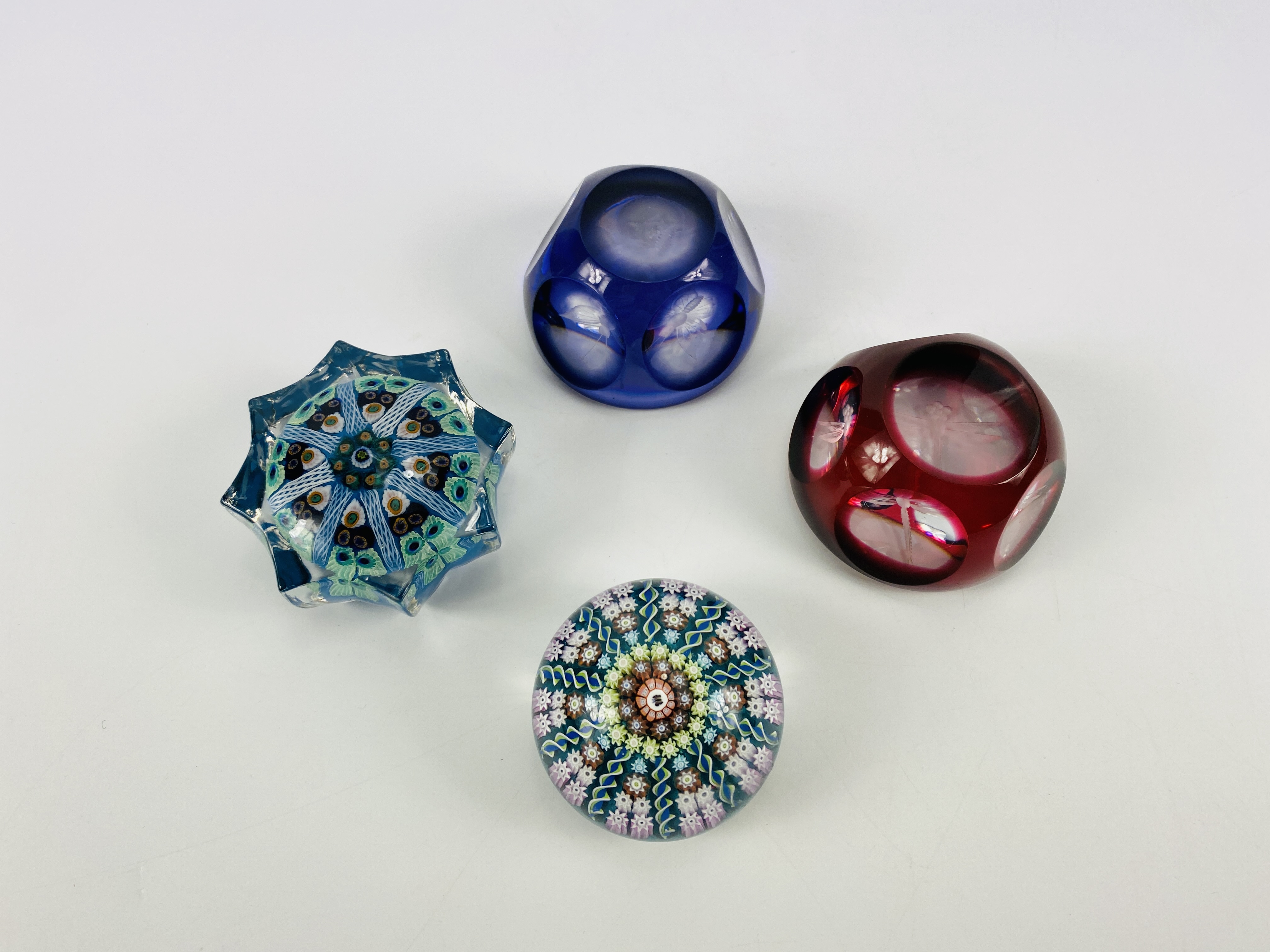 A collection of four paperweights to include two similar 'Webb Corbett ...