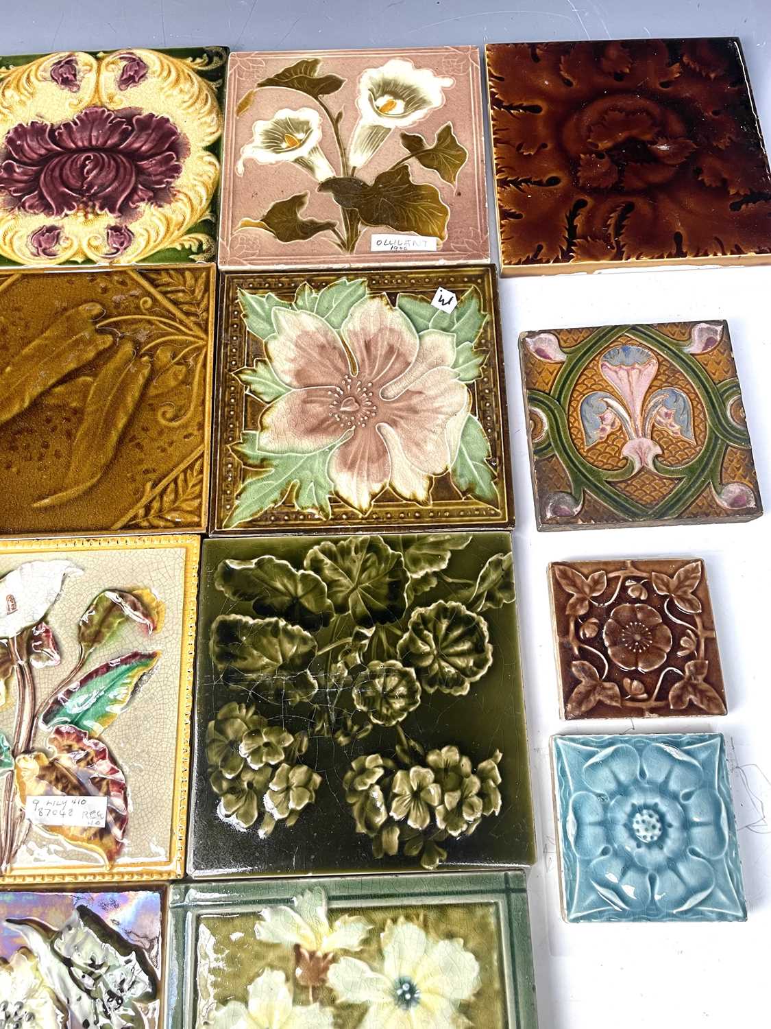 A collection of Victorian dust pressed relief moulded floral majolica ...