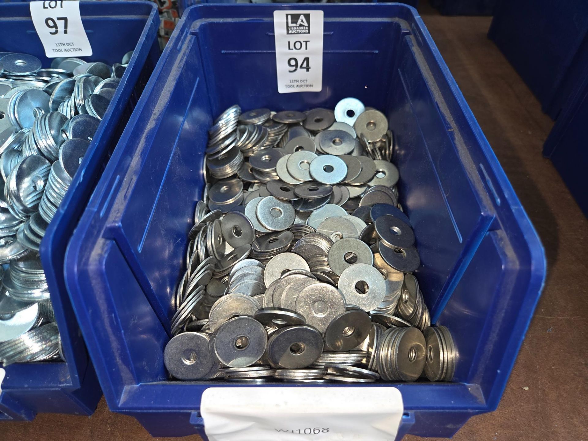 BLUE STORAGE TUB OF WASHERS