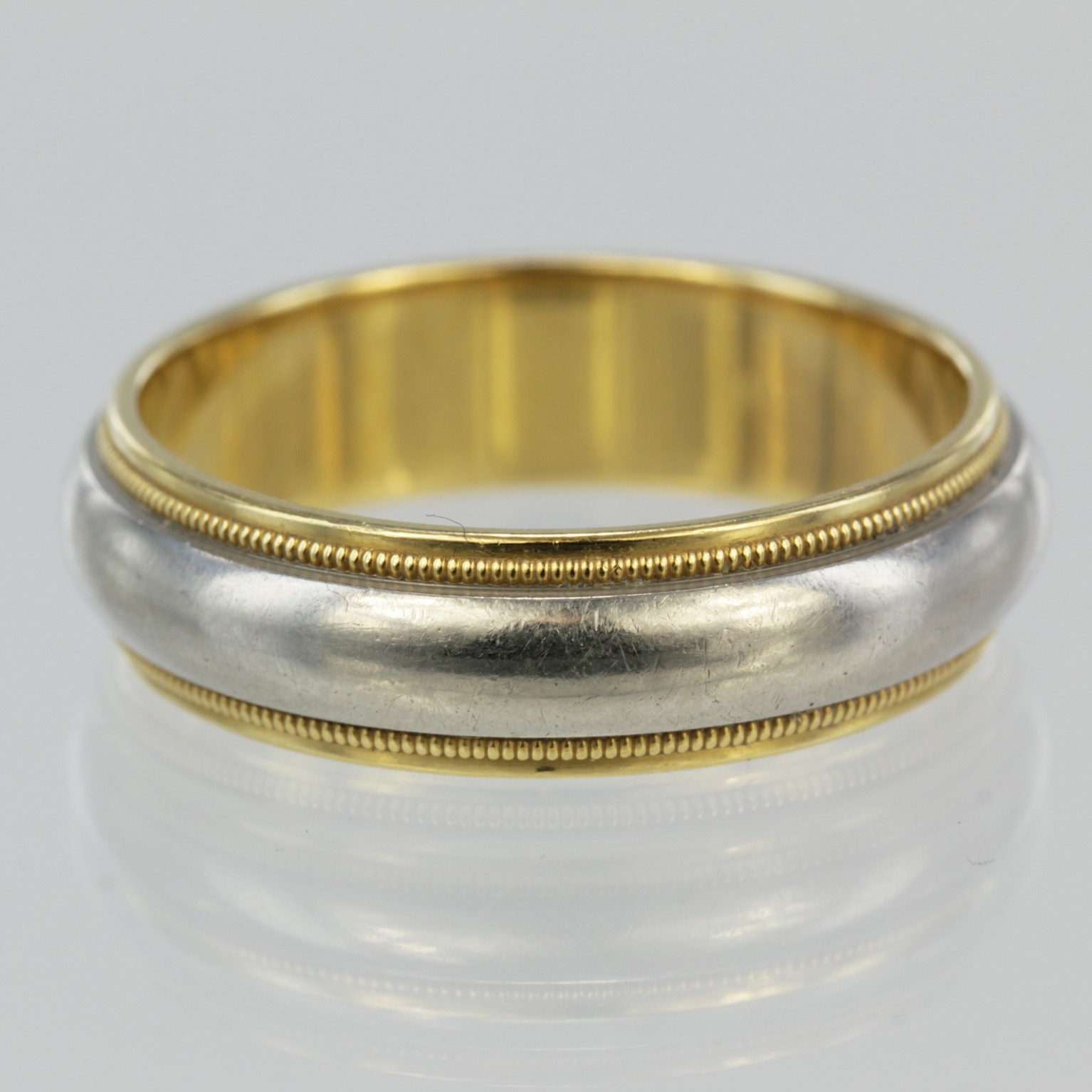 Boxed and signed Tiffany & Co wedding ring, yellow and white metal ...