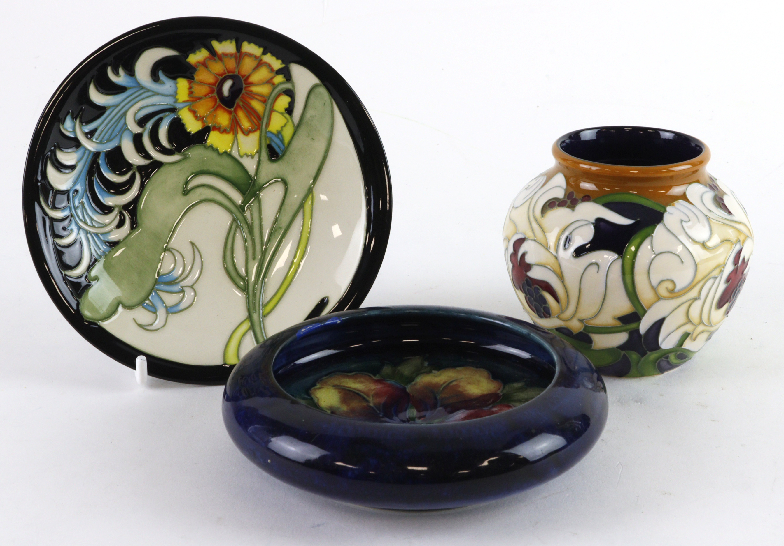 Moorcroft. Three pieces of Moorcroft pottery, comprising two dishes and ...