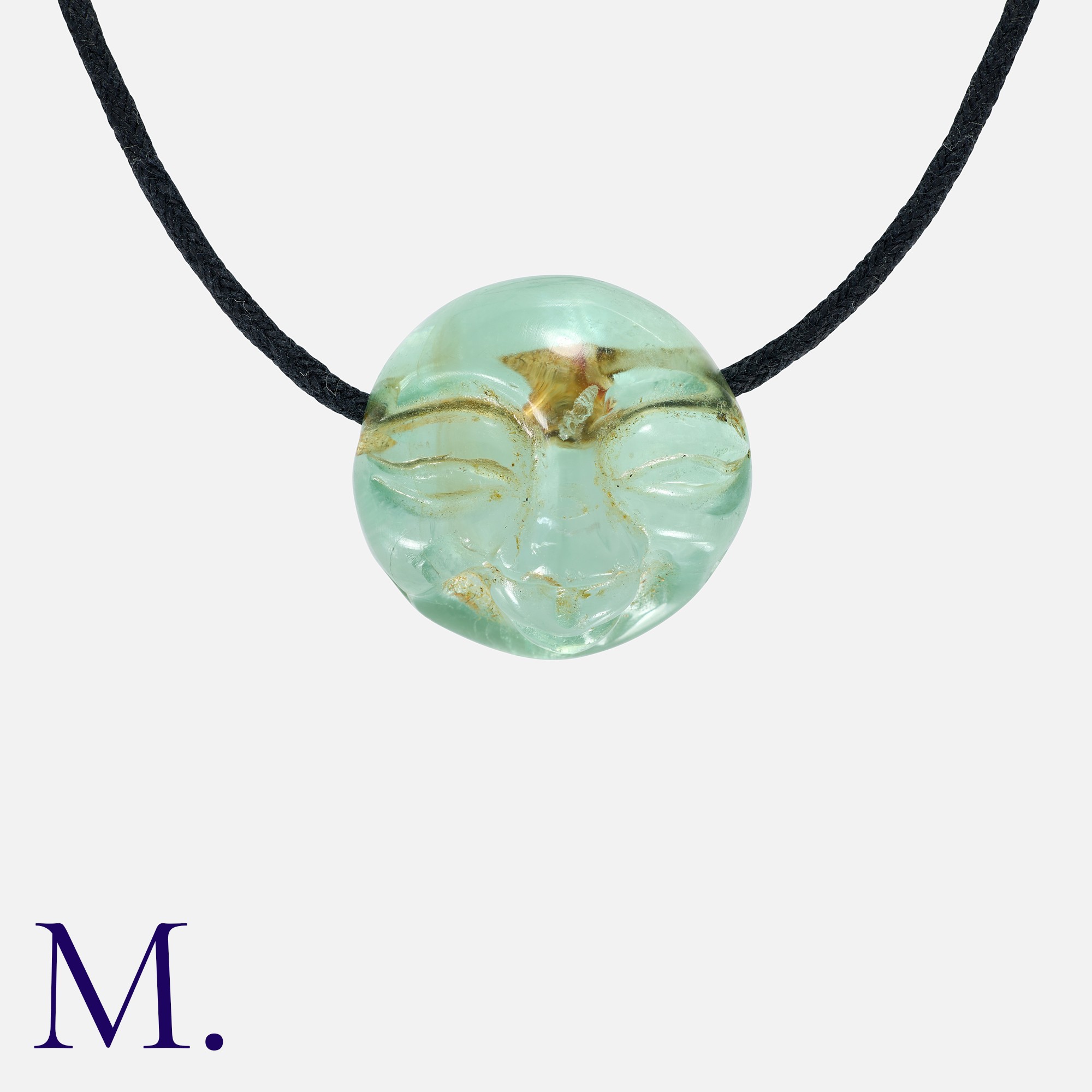 A Green Beryl Man-in-the-Moon Pendant carved in beryl and suspended ...