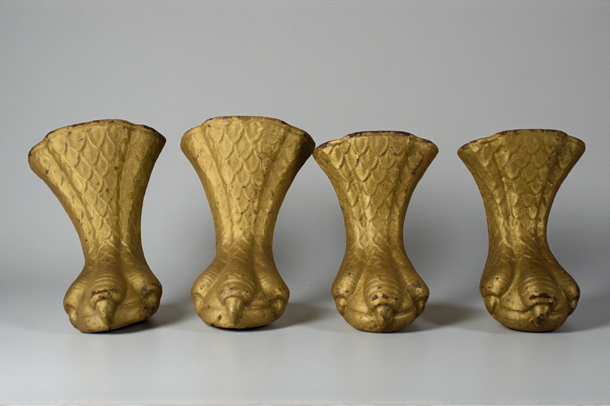 A set of antique cast iron gilt ball & claw bathtub feet.