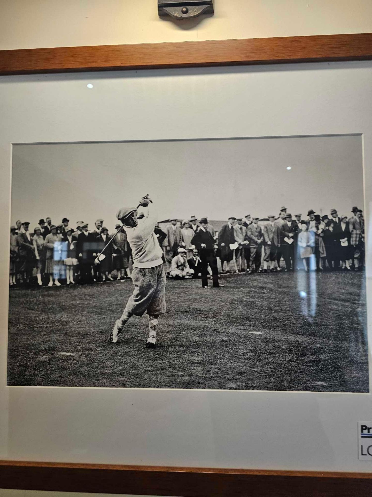 A black and white photoprint depicting a male golfer mid-swing during a ...