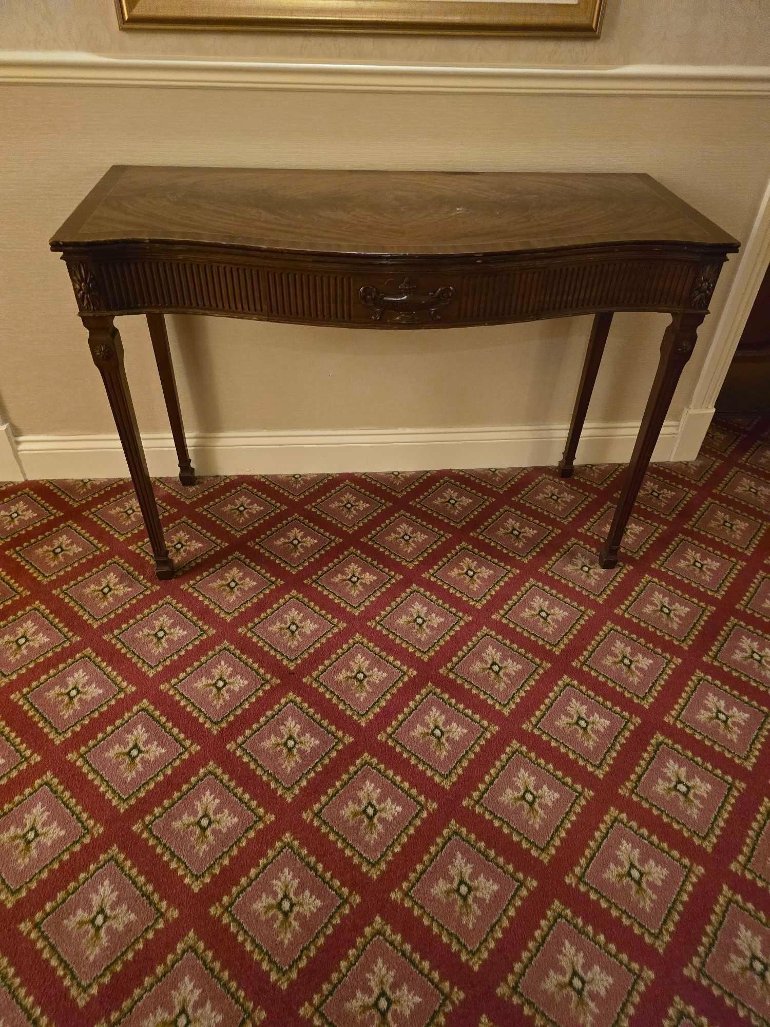 A neoclassical style serpentine-front console table mahogany. The ...