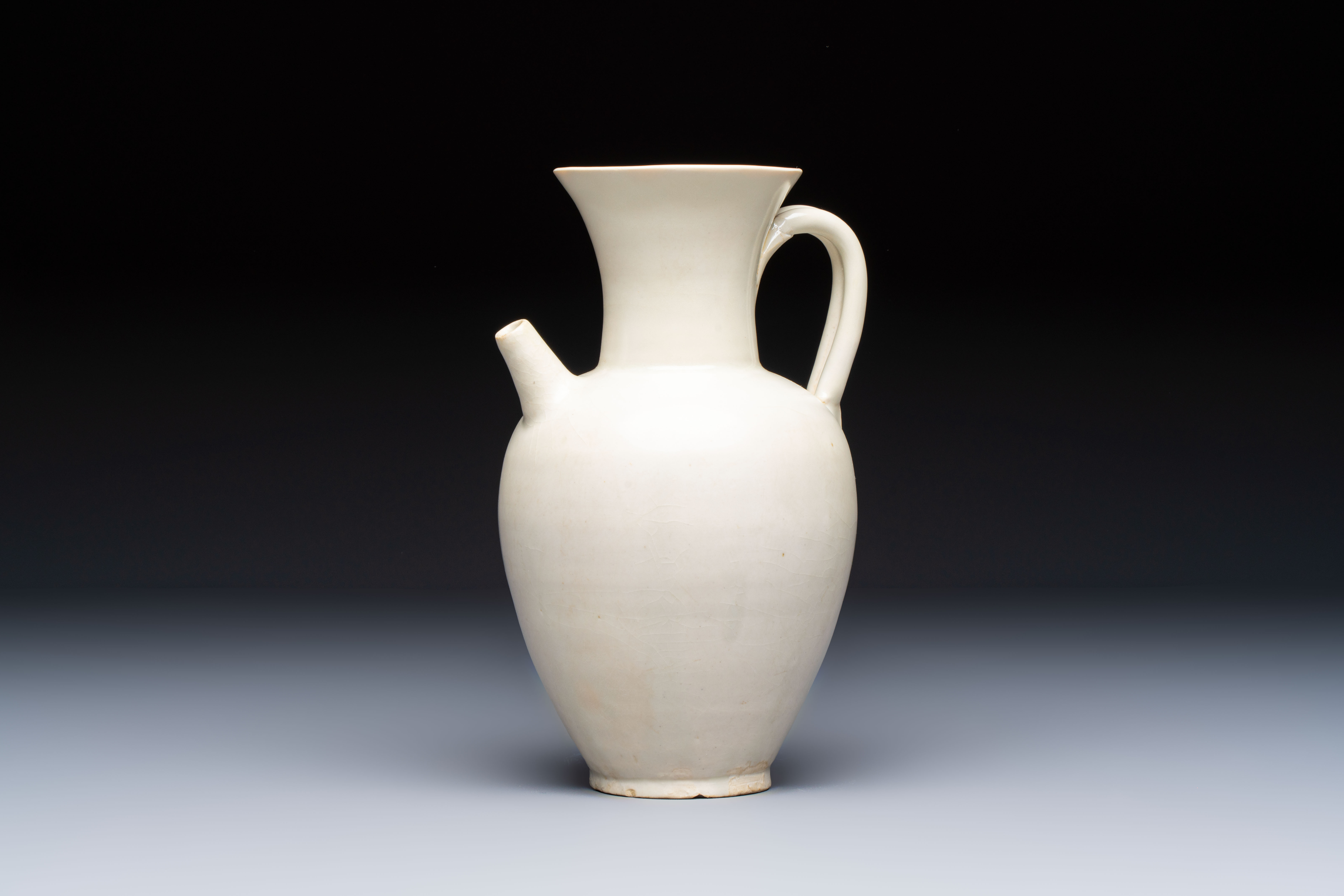 A Chinese Xingyao white-glazed ewer, Ying mark, Tang or laterH.: 19,5 ...