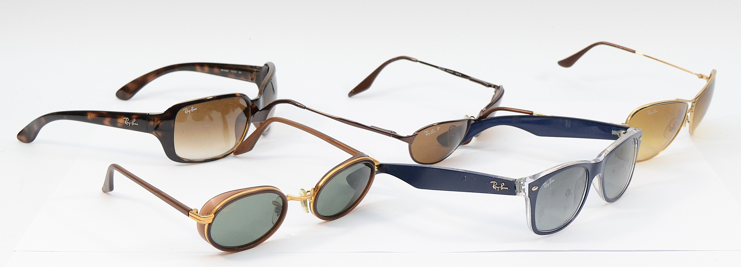 Five pairs of designer Ray Ban sunglasses, in cases.