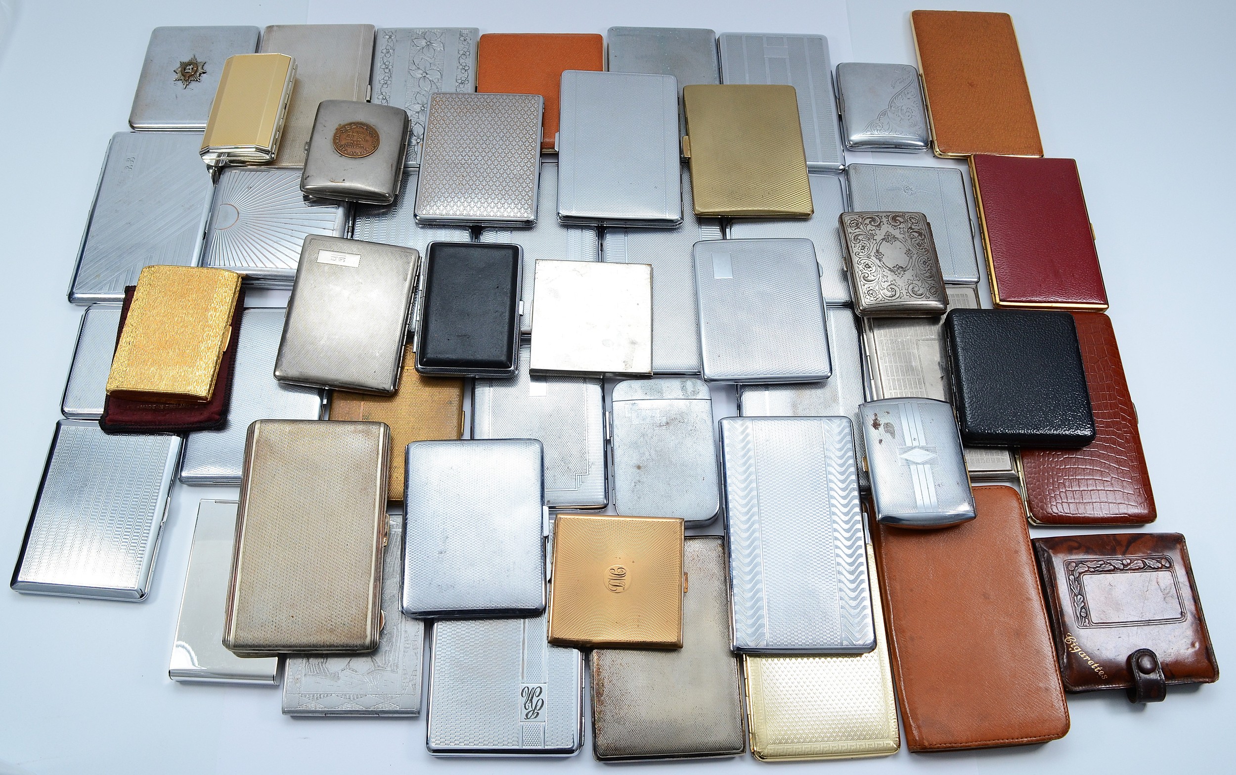 A collection of mid 20th century cigarette cases, including plated and ...