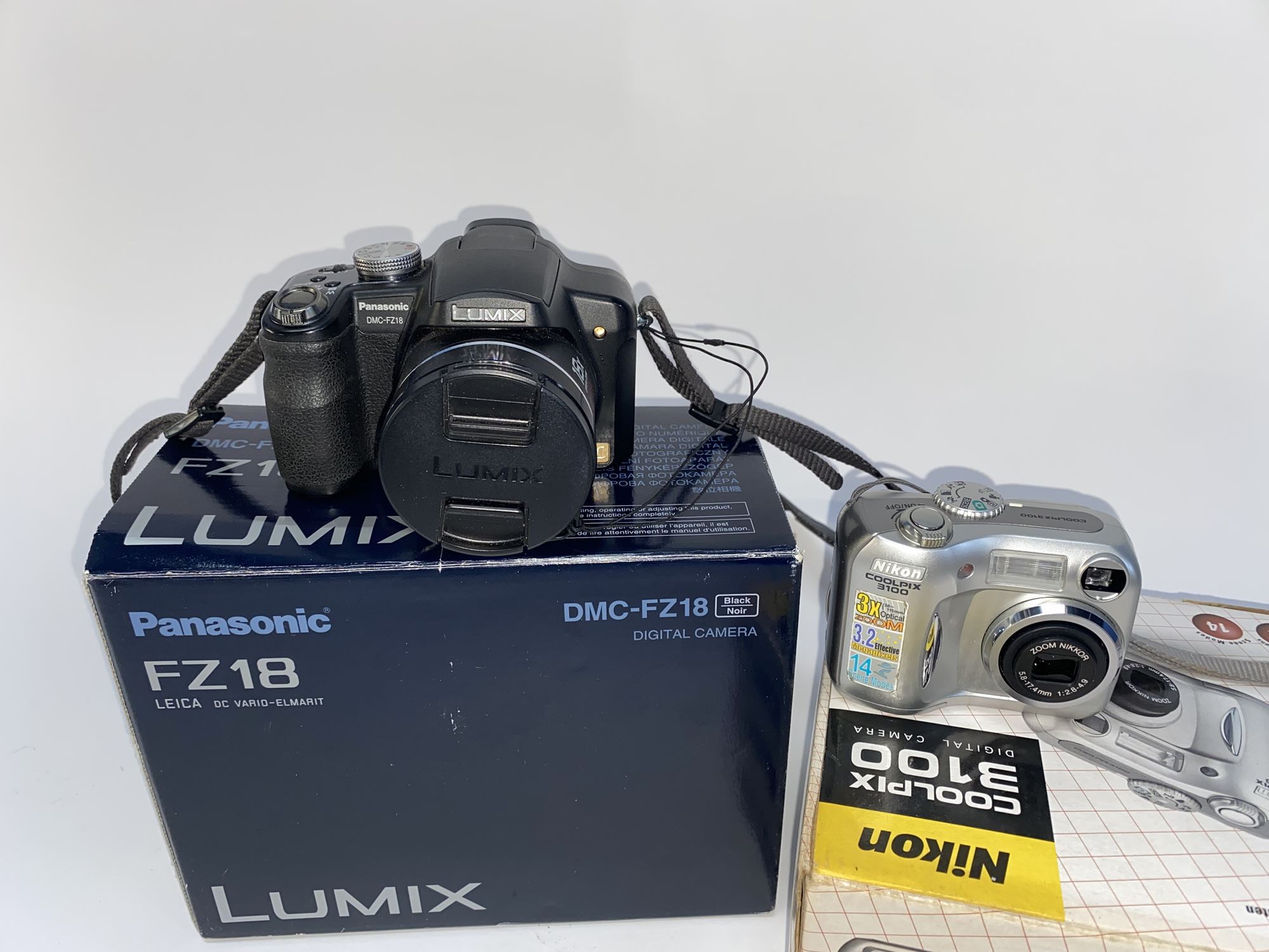 A Panasonic FZ18 Lumix camera and a Nikon Coolpix 3100