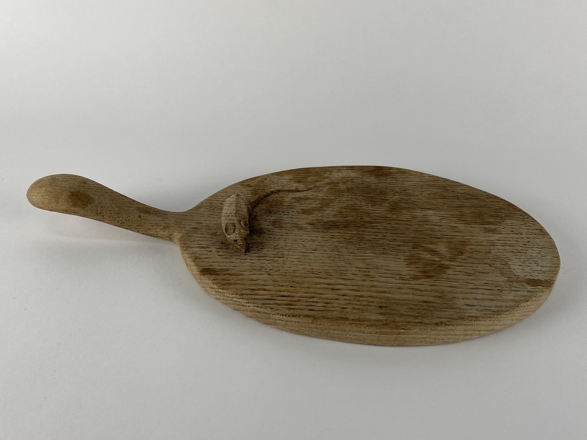 A Robert Thompson of Kilburn 'Mouseman' cheeseboard, L 34cm