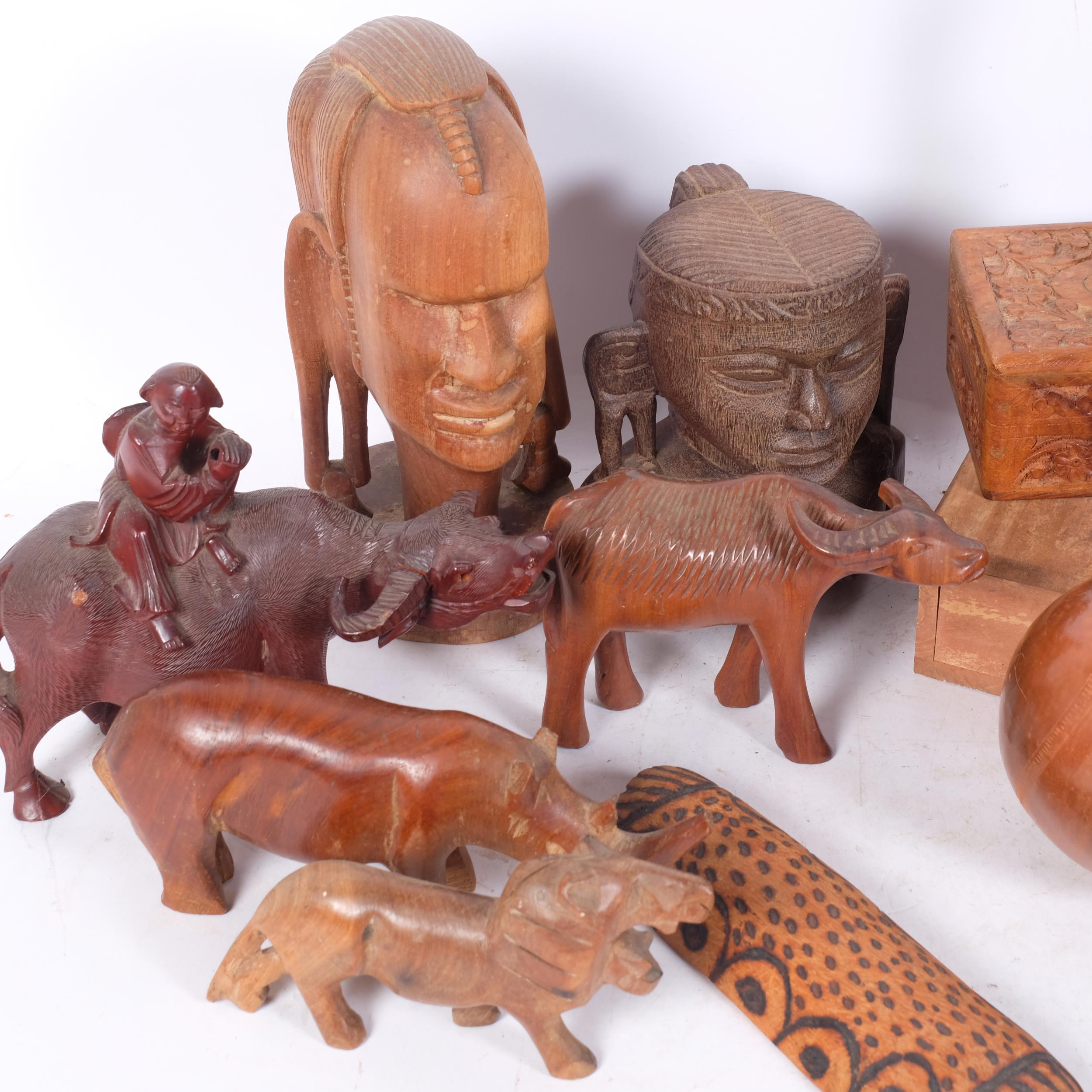 A large quantity of African carved treen items, including water buffalo ...
