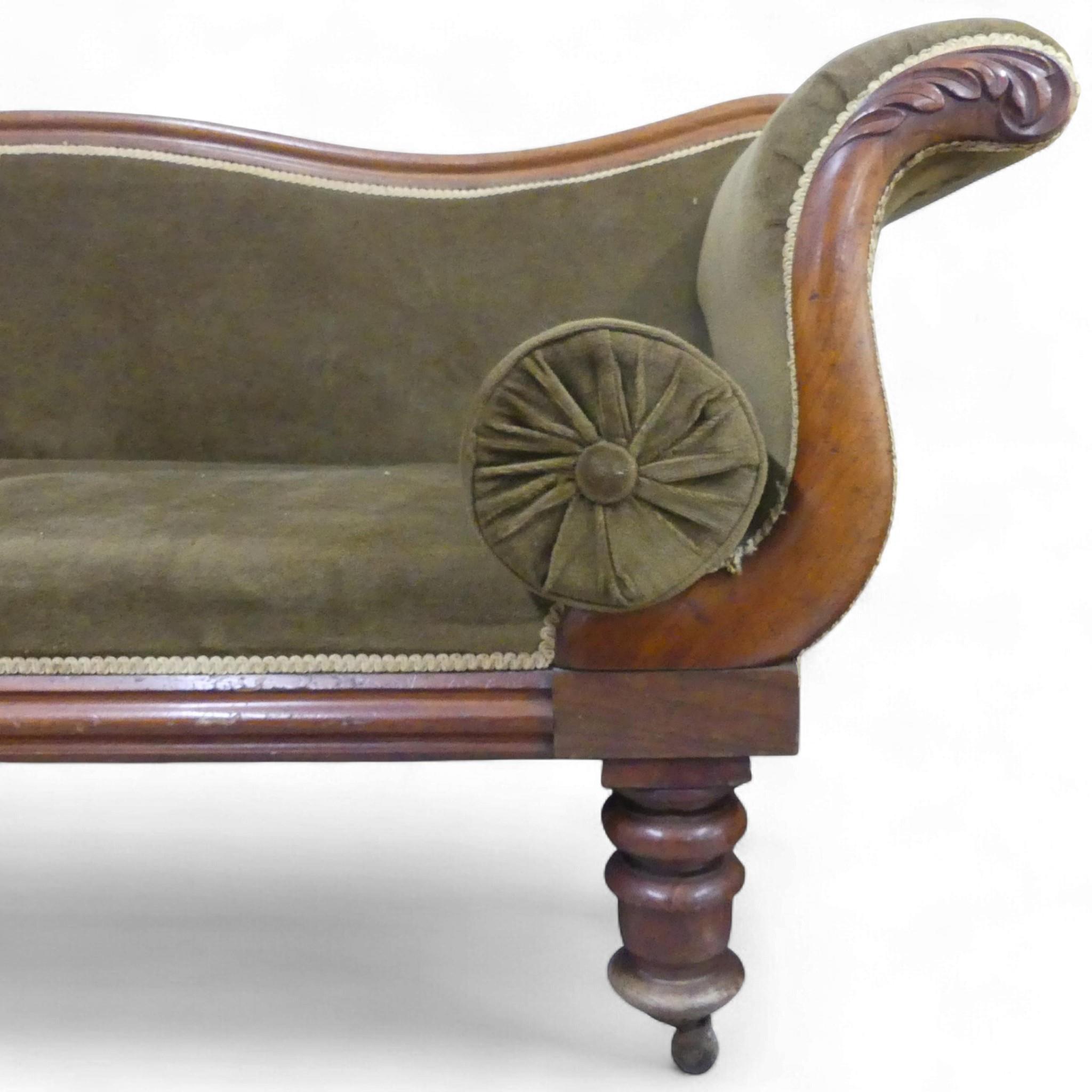 A Victorian mahogany and upholstered sofa, with camel back and scrolled ...